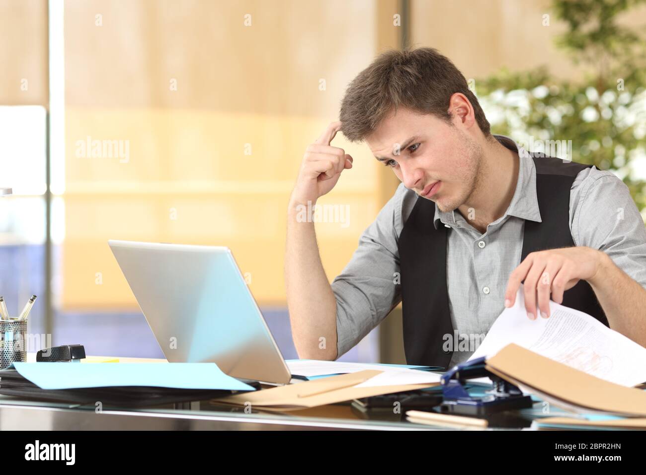 Incompetent businessman thinking how to do his job online with messy ...