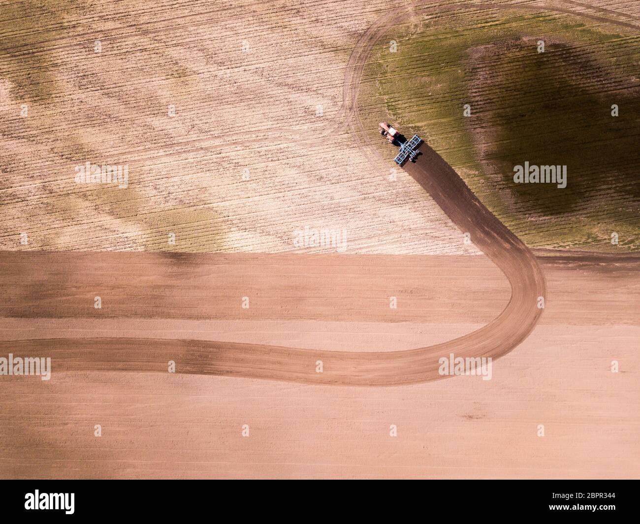 Aerial view of the tractor in the field, agricultural field work ...