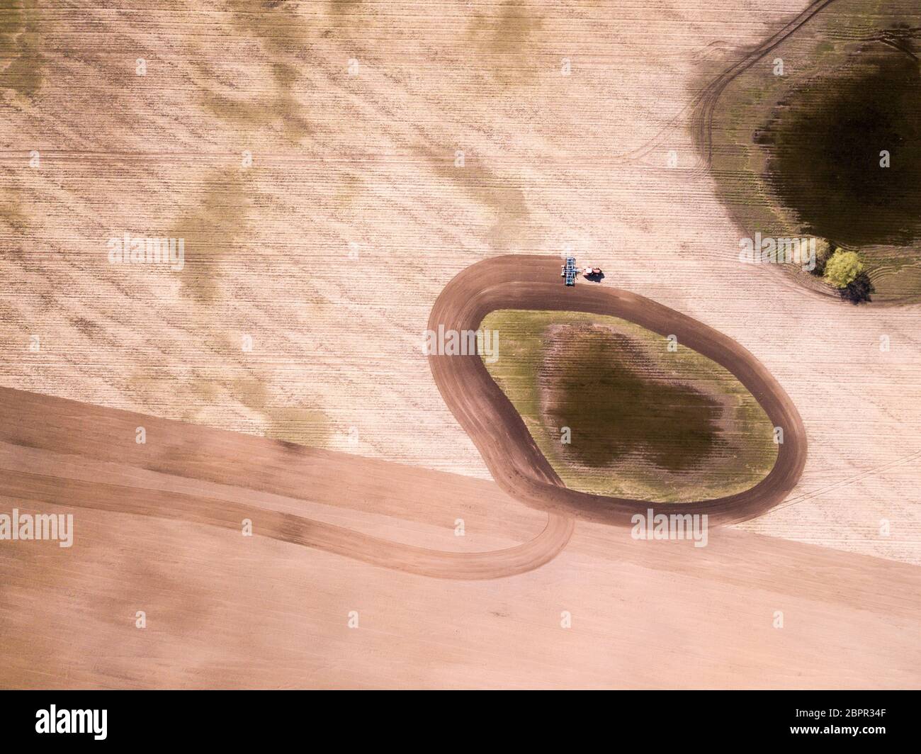 Aerial view of the tractor in the field, agricultural field work ...