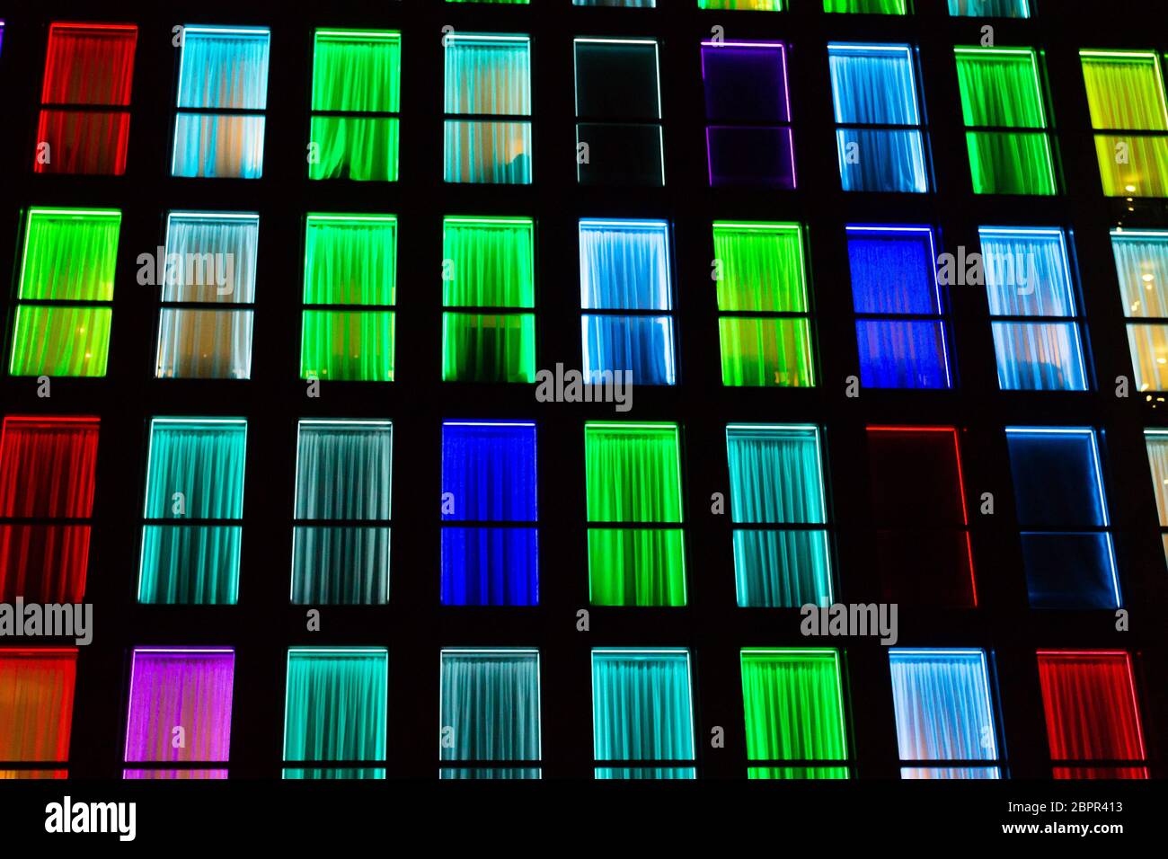 Colored windows texture. Windows illuminated by neon lights background ...