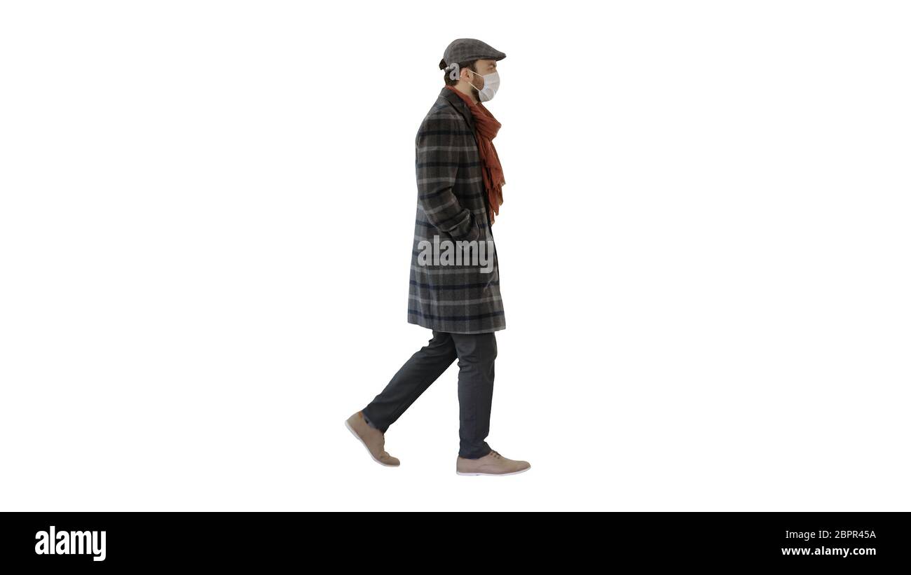 Gentleman wearing a protective face mask walking on white background ...