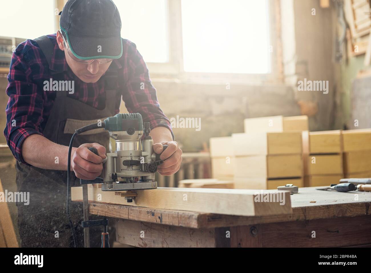 Worker grinds the wood box of angular grinding machine. Profession ...