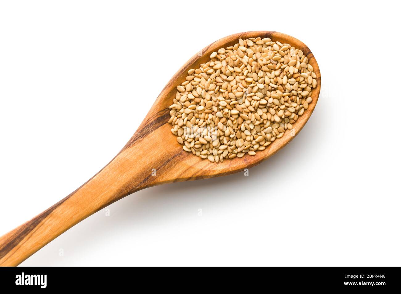 Roasted sesame seeds in wooden spoon isolated on white background Stock ...