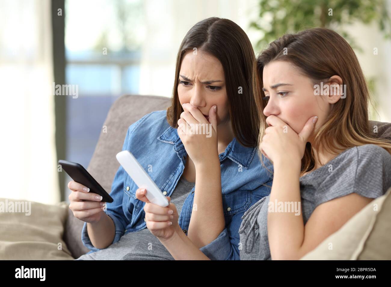 Two friends chat home unhappy hi-res stock photography and images - Alamy