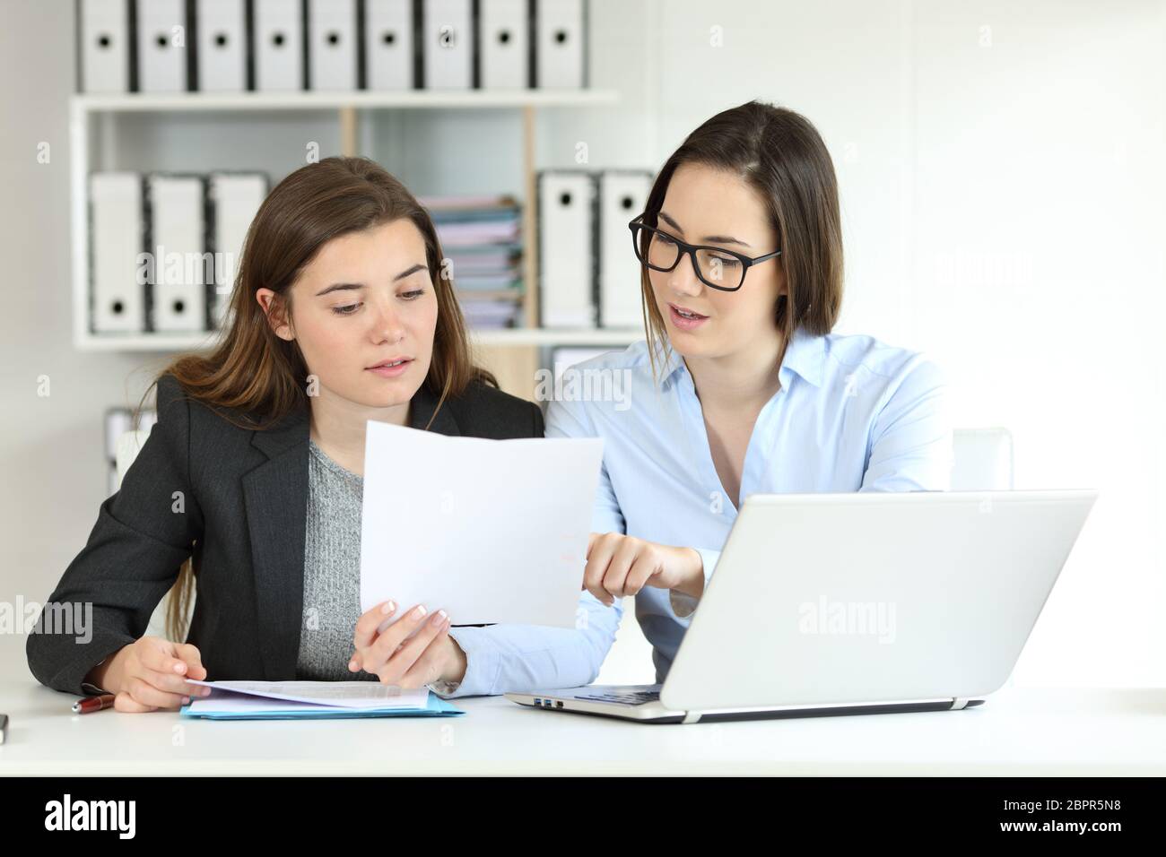 Two concentrated office workers coworking comparing documents Stock ...