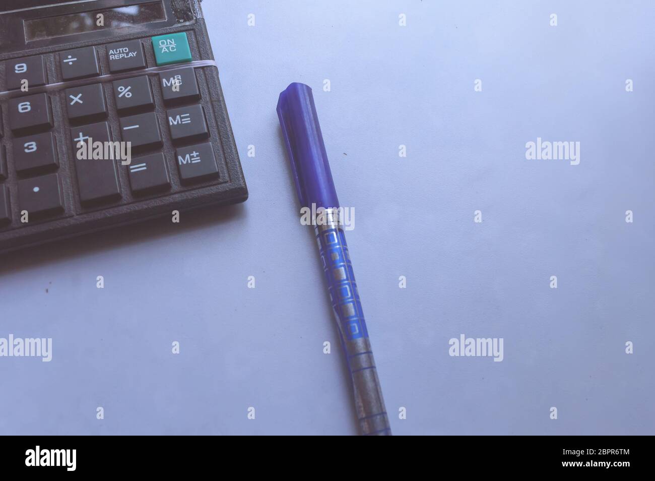 pen and calculator or calculating machine on white background ...