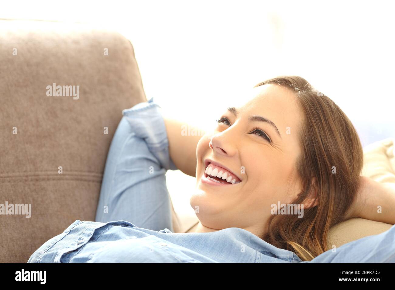 Woman being lazy on sofa hi-res stock photography and images - Alamy