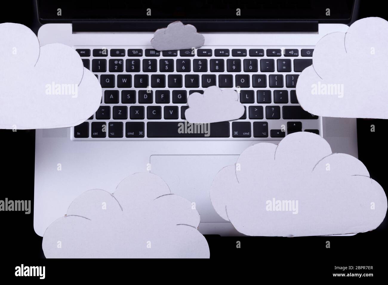 Cloud computing concept with cutout clouds above a laptop computer ...