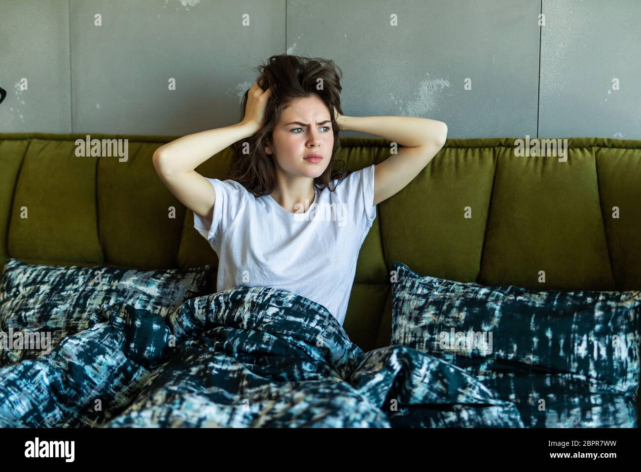 Amazed beautiful young woman wake up in white bed and shocked Stock ...