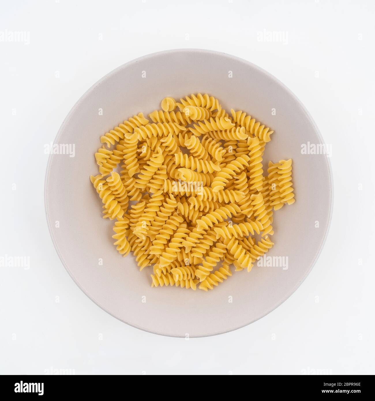 dried Fusilli pasta on a plate Stock Photo - Alamy