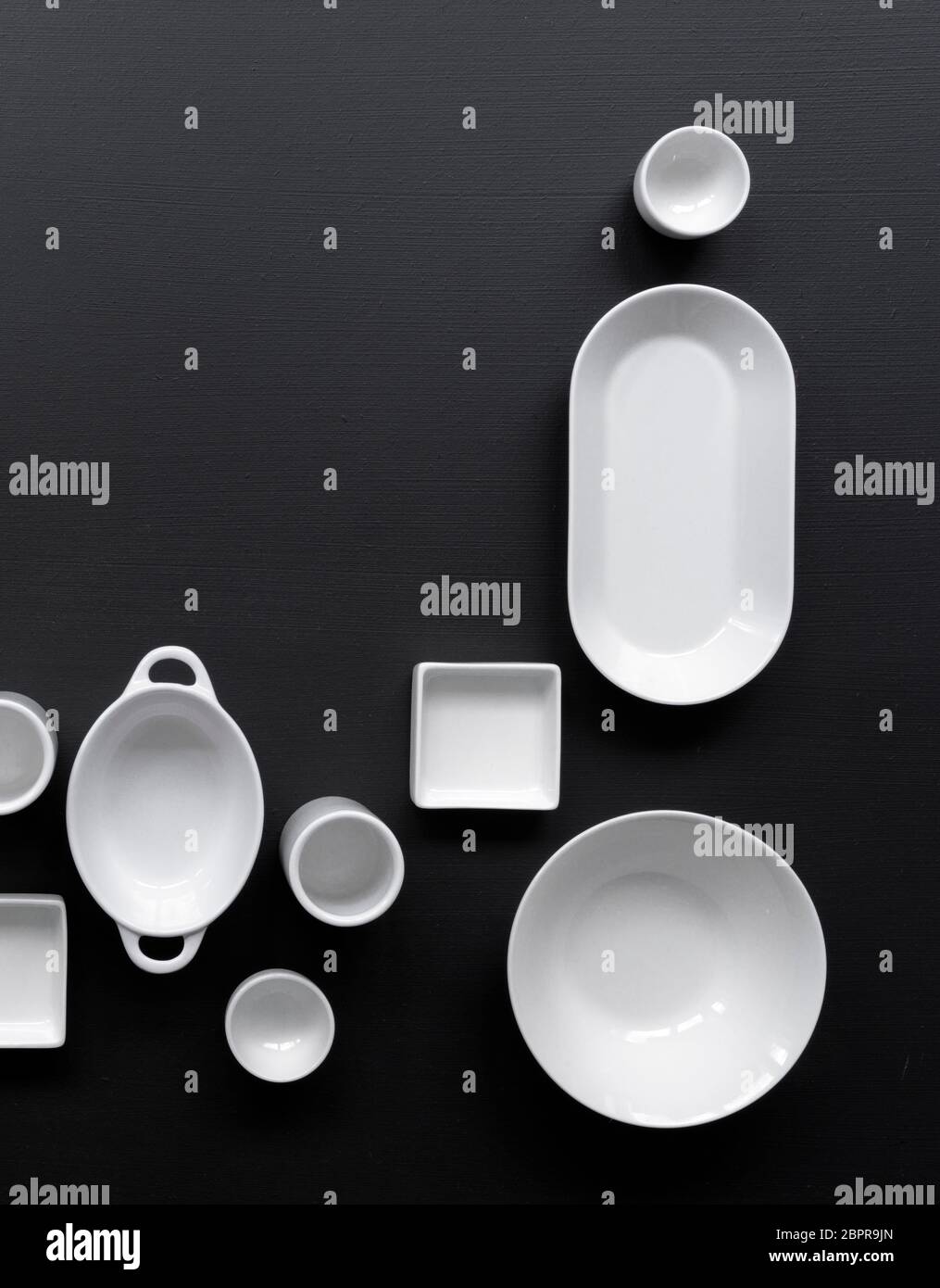 white, modern tableware in various designs on a black background Stock ...