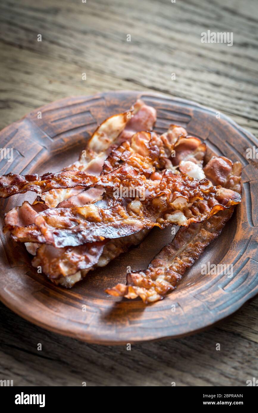 Fried bacon strips on the plate Stock Photo - Alamy