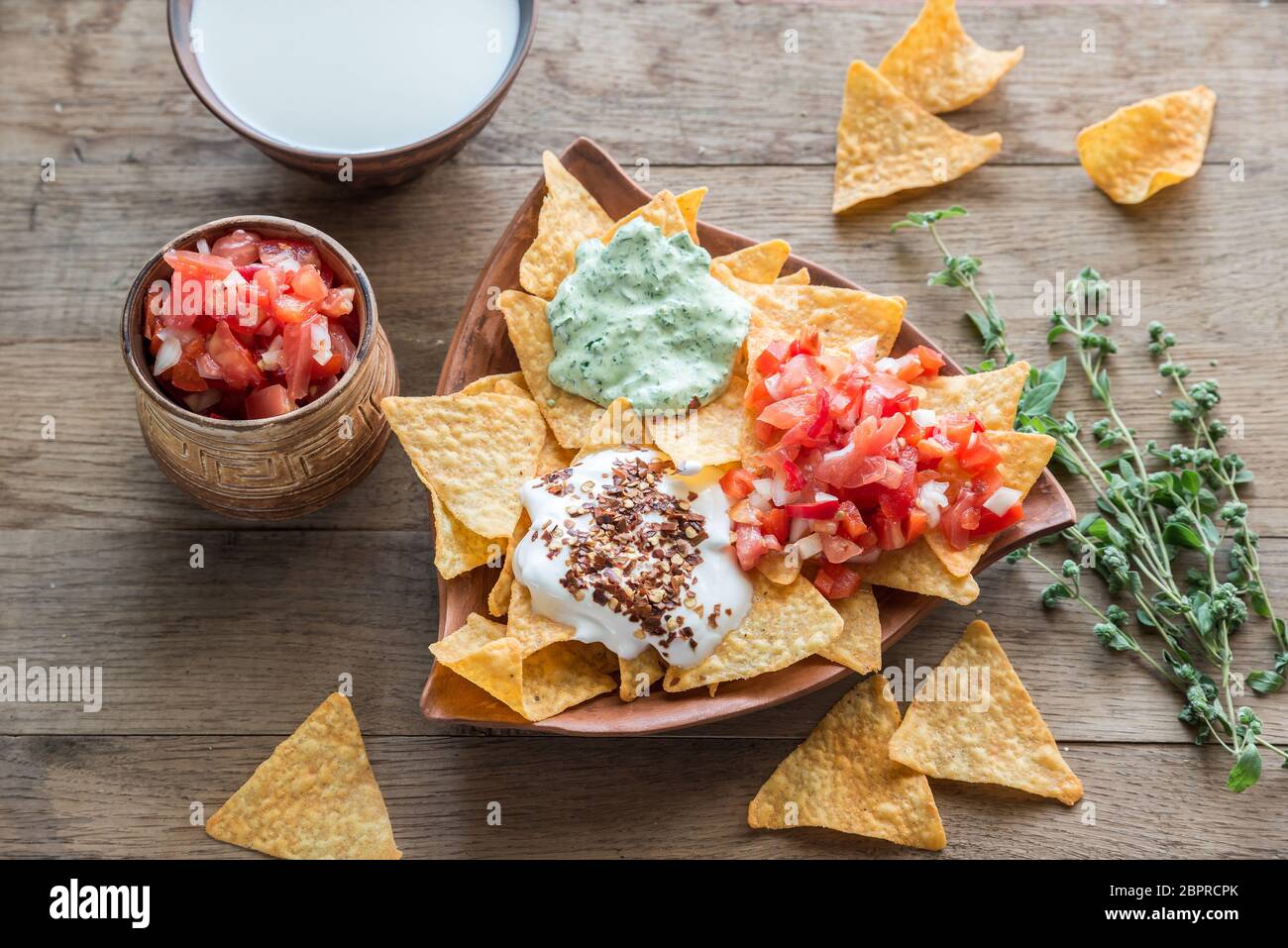 Cheese nachos with different types of sauce Stock Photo - Alamy