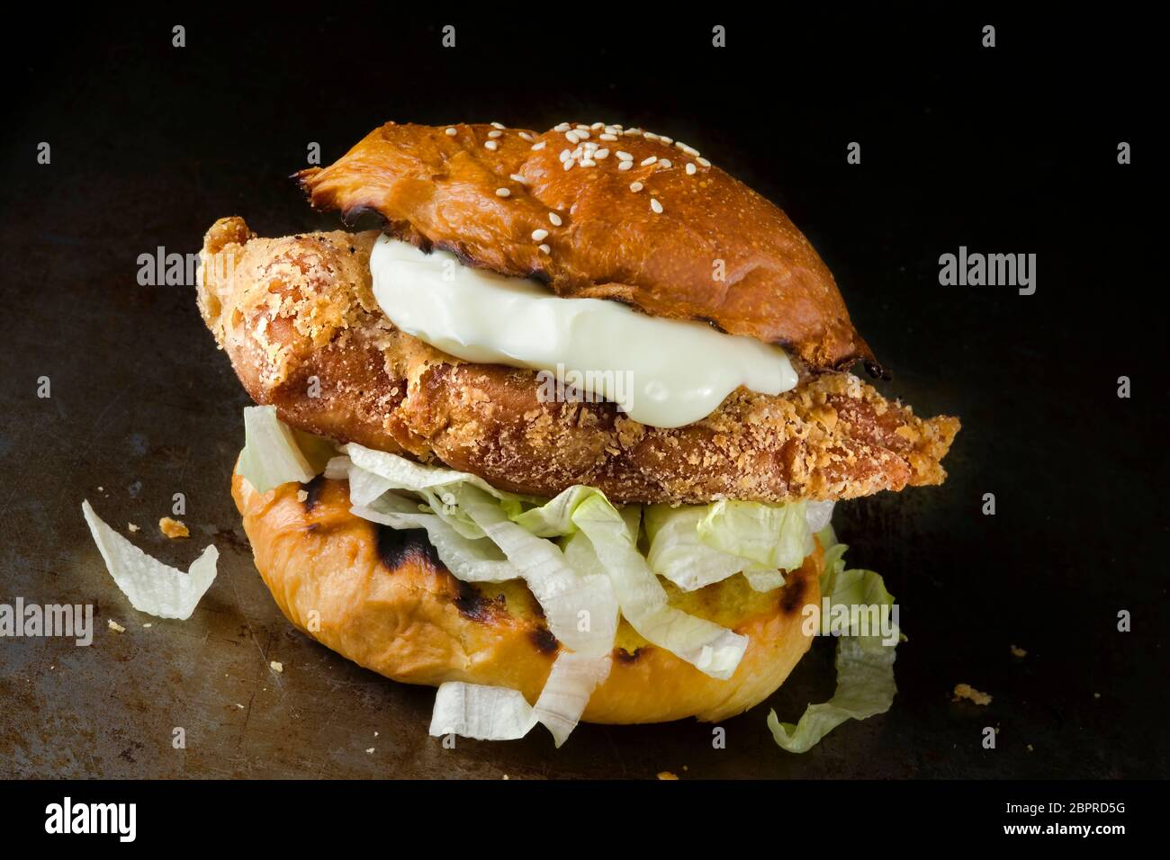 close up of rustic golden chicken burger Stock Photo - Alamy