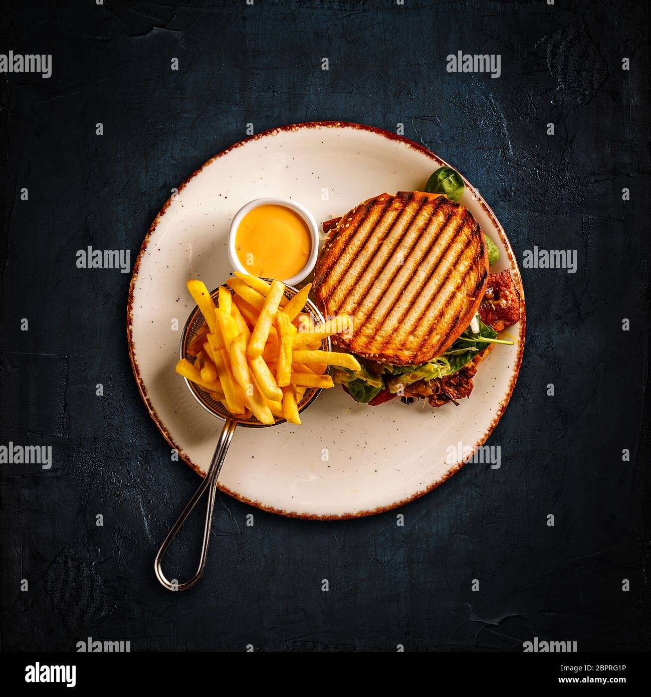Delicious pub style pulled pork sandwich with french fries Stock Photo ...