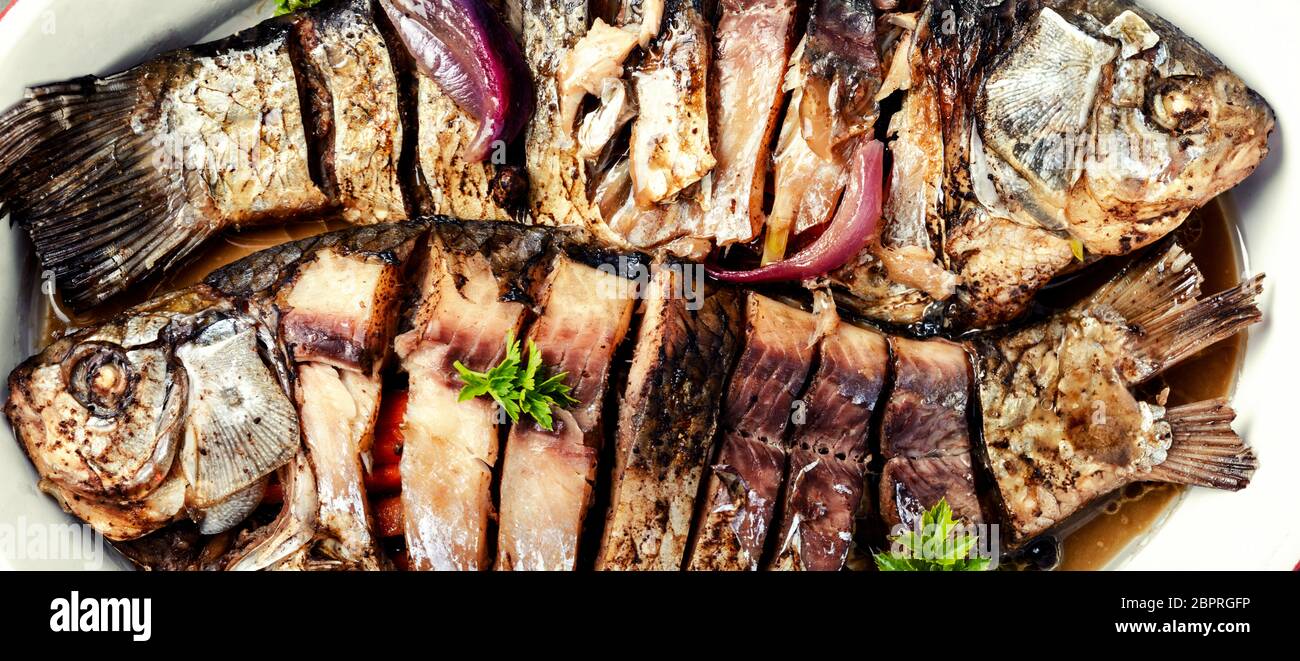 Grilled whole fish with citrus,vegetable and spices on rustic kitchen ...