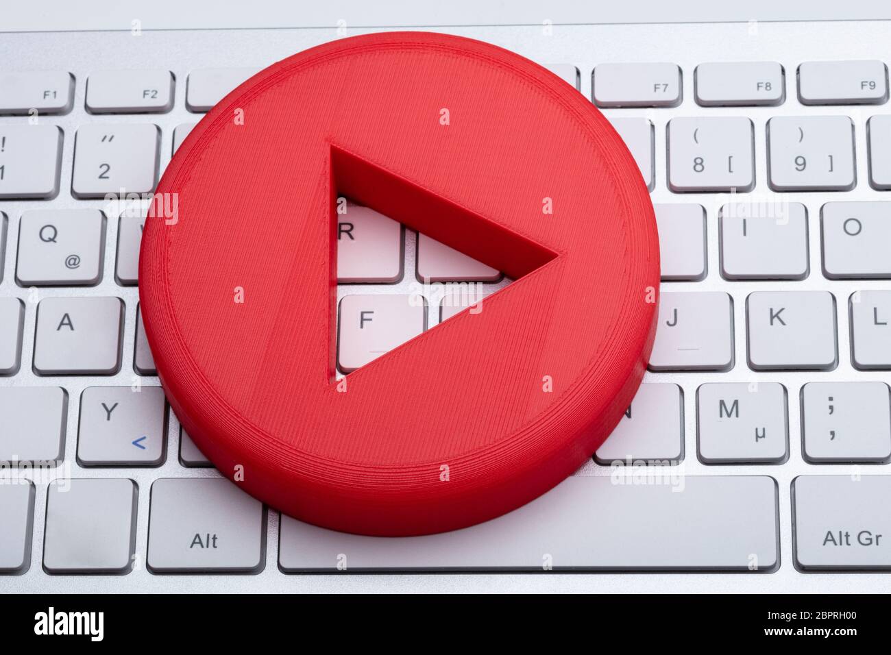 An Elevated View Of Red Play Button On White Keyboard Stock Photo - Alamy