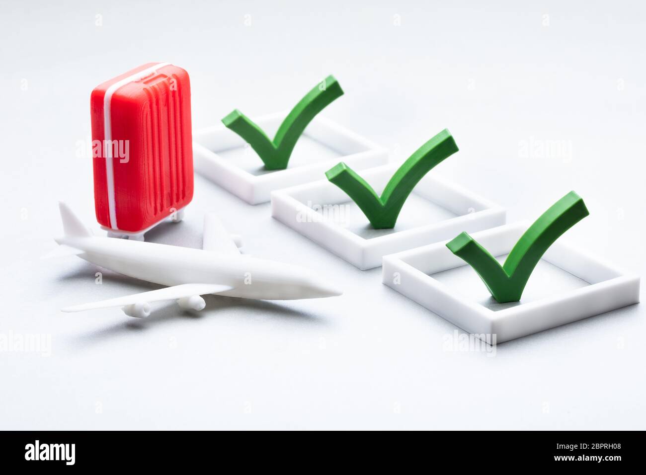 Miniature Red Bag And Plane With Checklist On White Backdrop Stock ...
