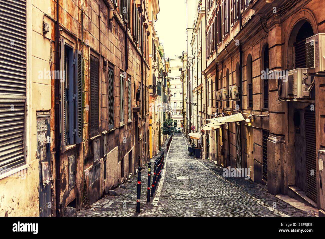 Traditional narrow Italian street with a cafe and no people Stock Photo ...