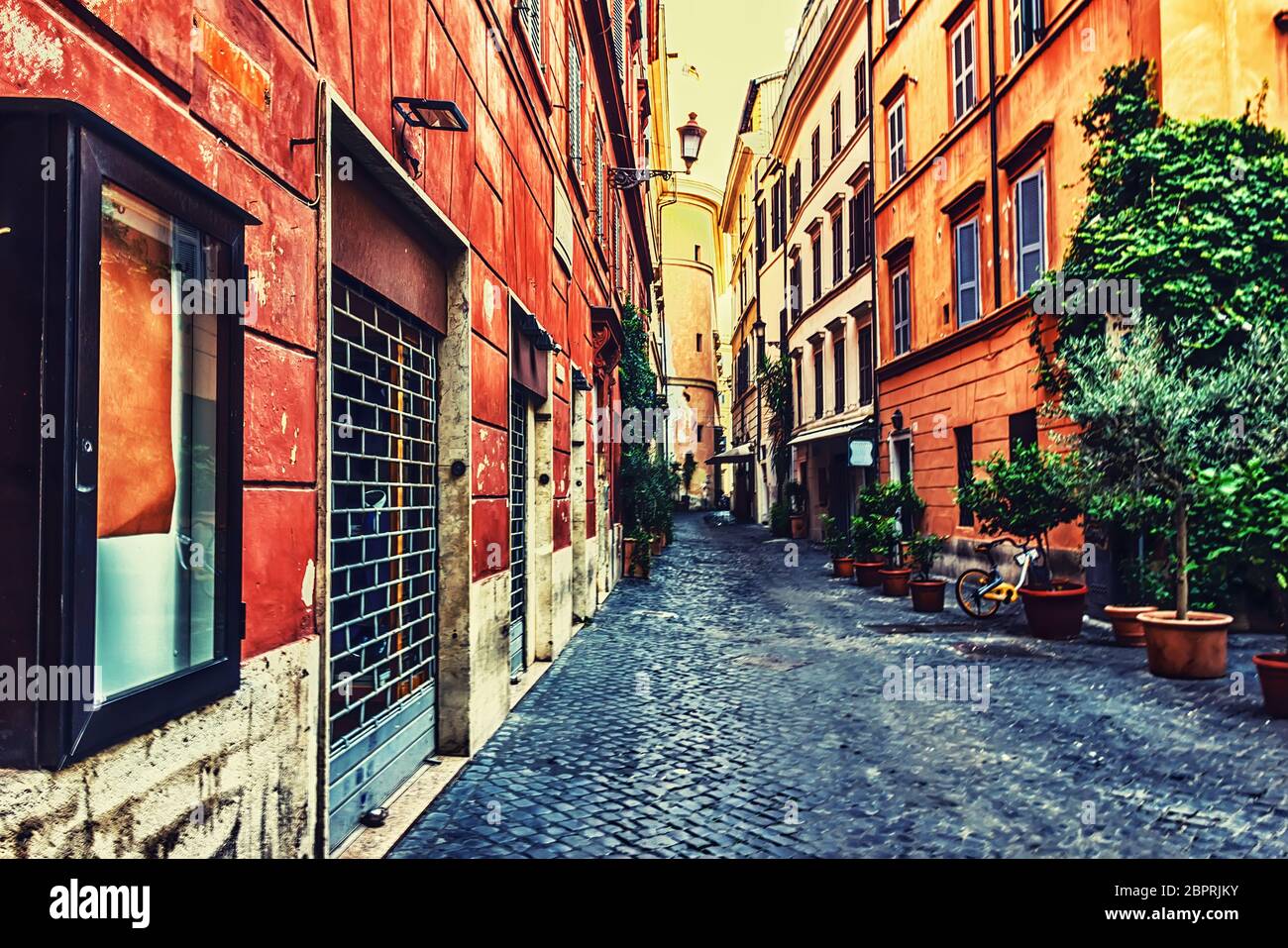 Italian Street with facade garages, flowerpots and bright buildings ...