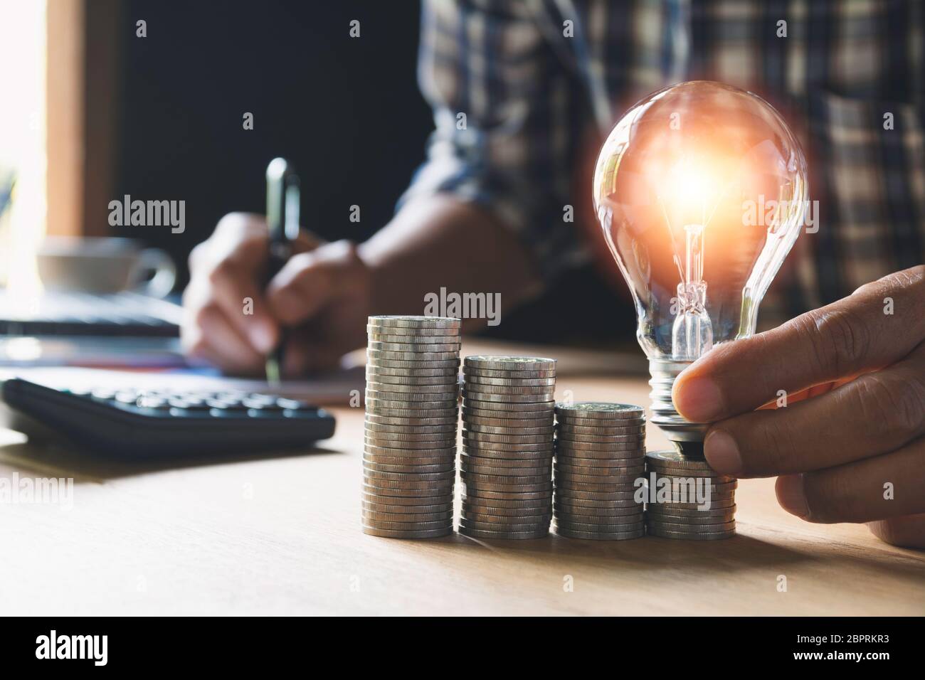 Hand of male holding a light bulb and copy space for accounting, ideas ...