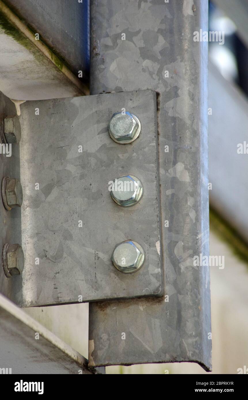 metal building: detail of vertical structure joined with bolts to the ...