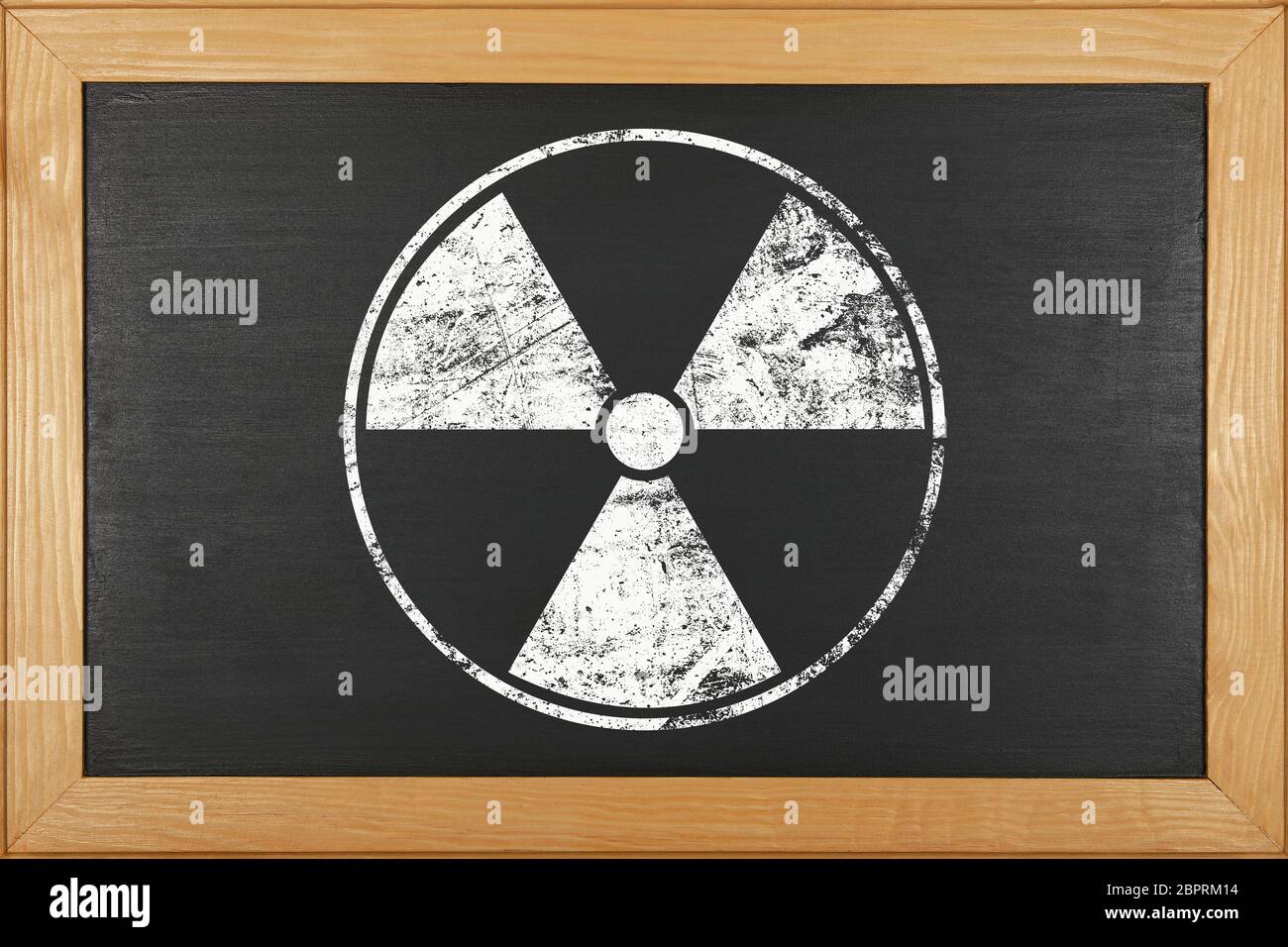 White chalk radioactive hazard warning sign over grunge black ...