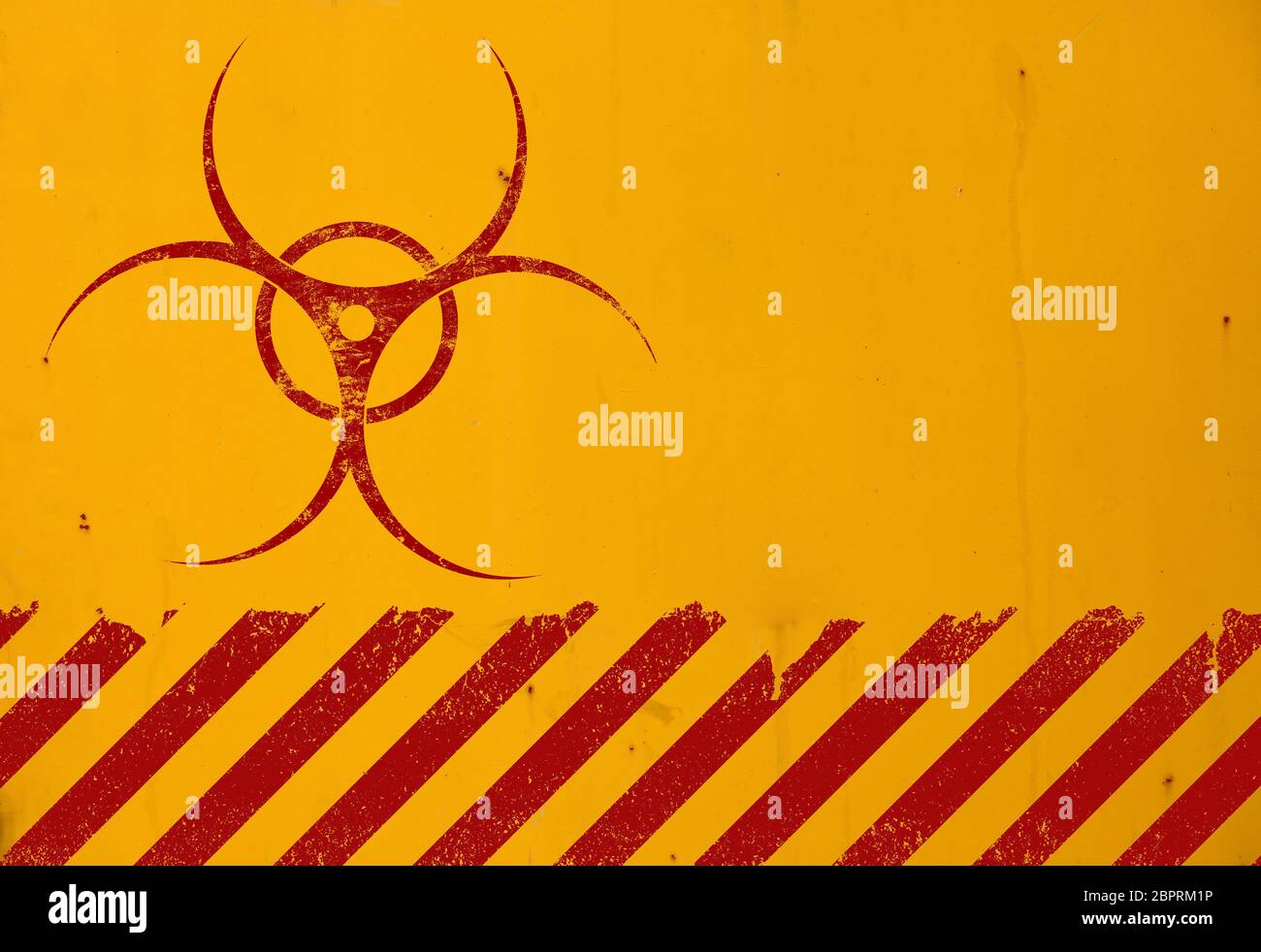 Dark red biohazard warning sign painted over grunge yellow background ...