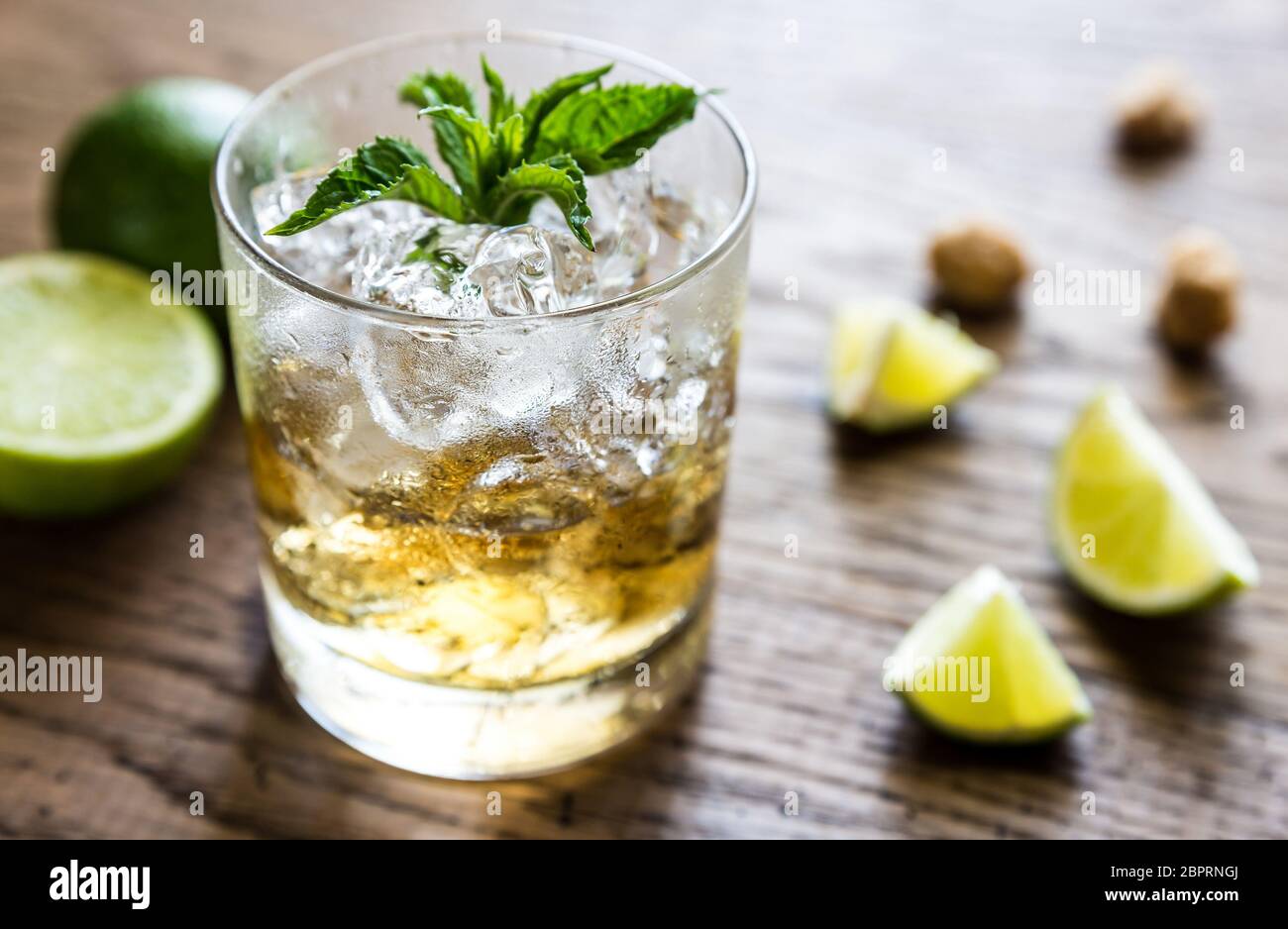 Glass of rum on the wooden background Stock Photo - Alamy