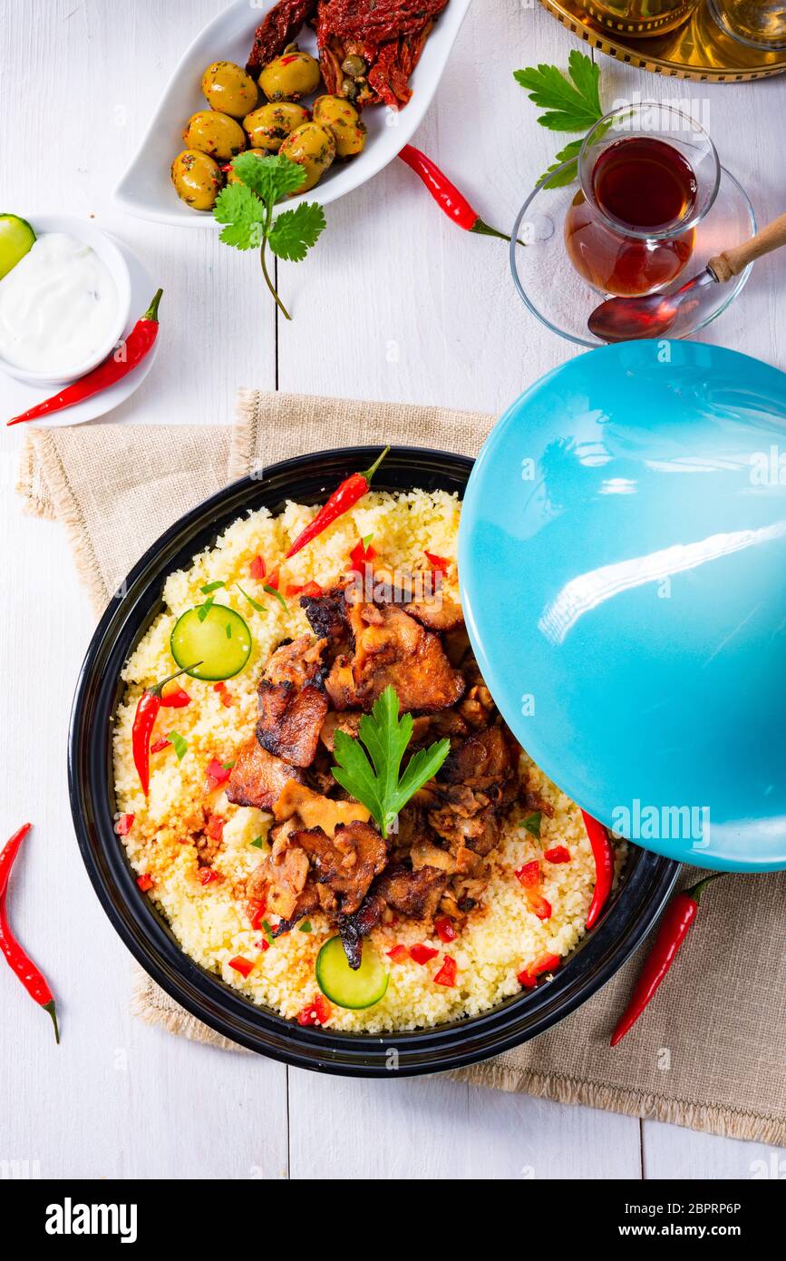 Tajin with couscous, vegetables and meat on white background Stock ...