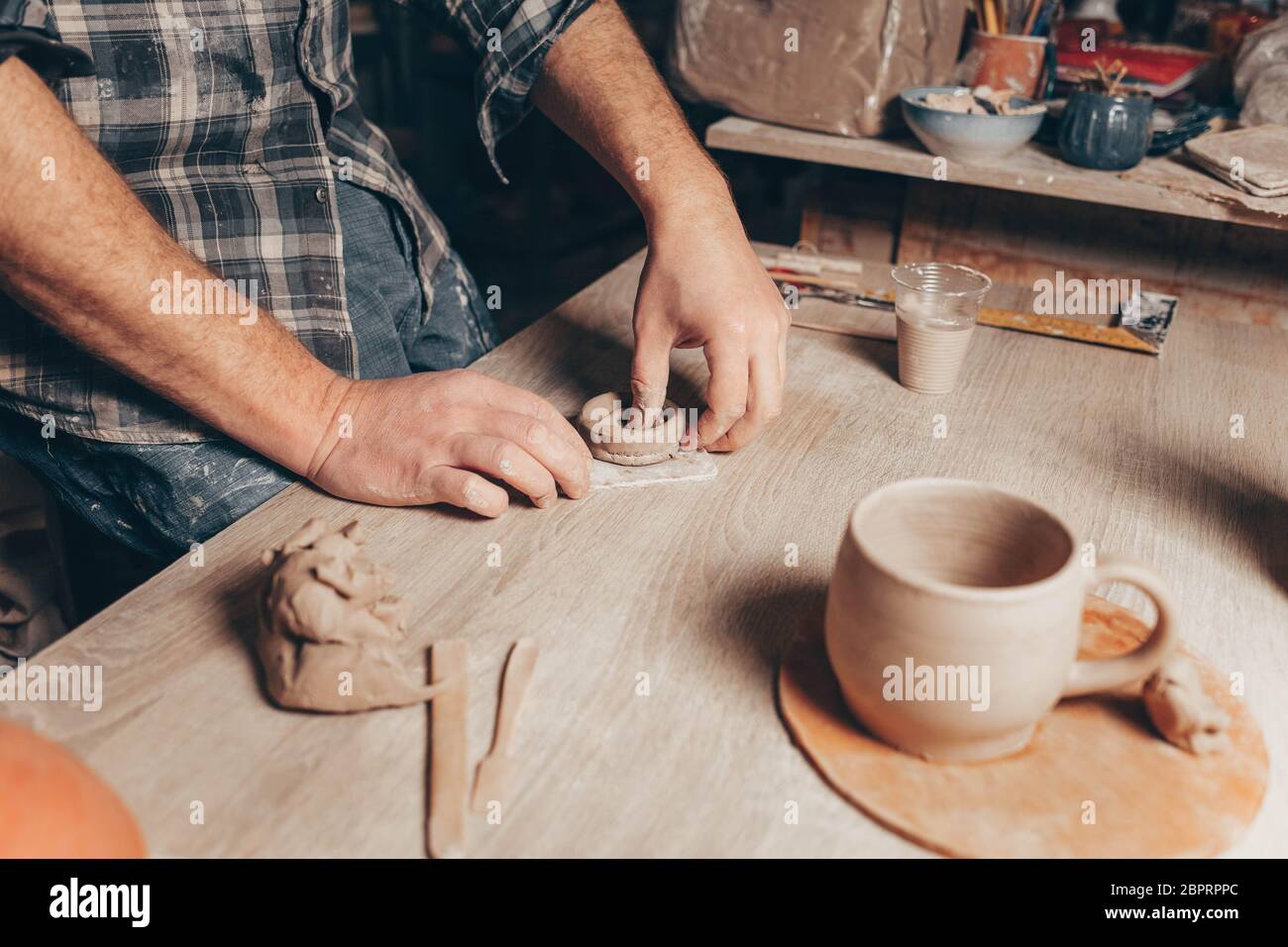 Process of creating a clay cup in pottery workshop Stock Photo - Alamy