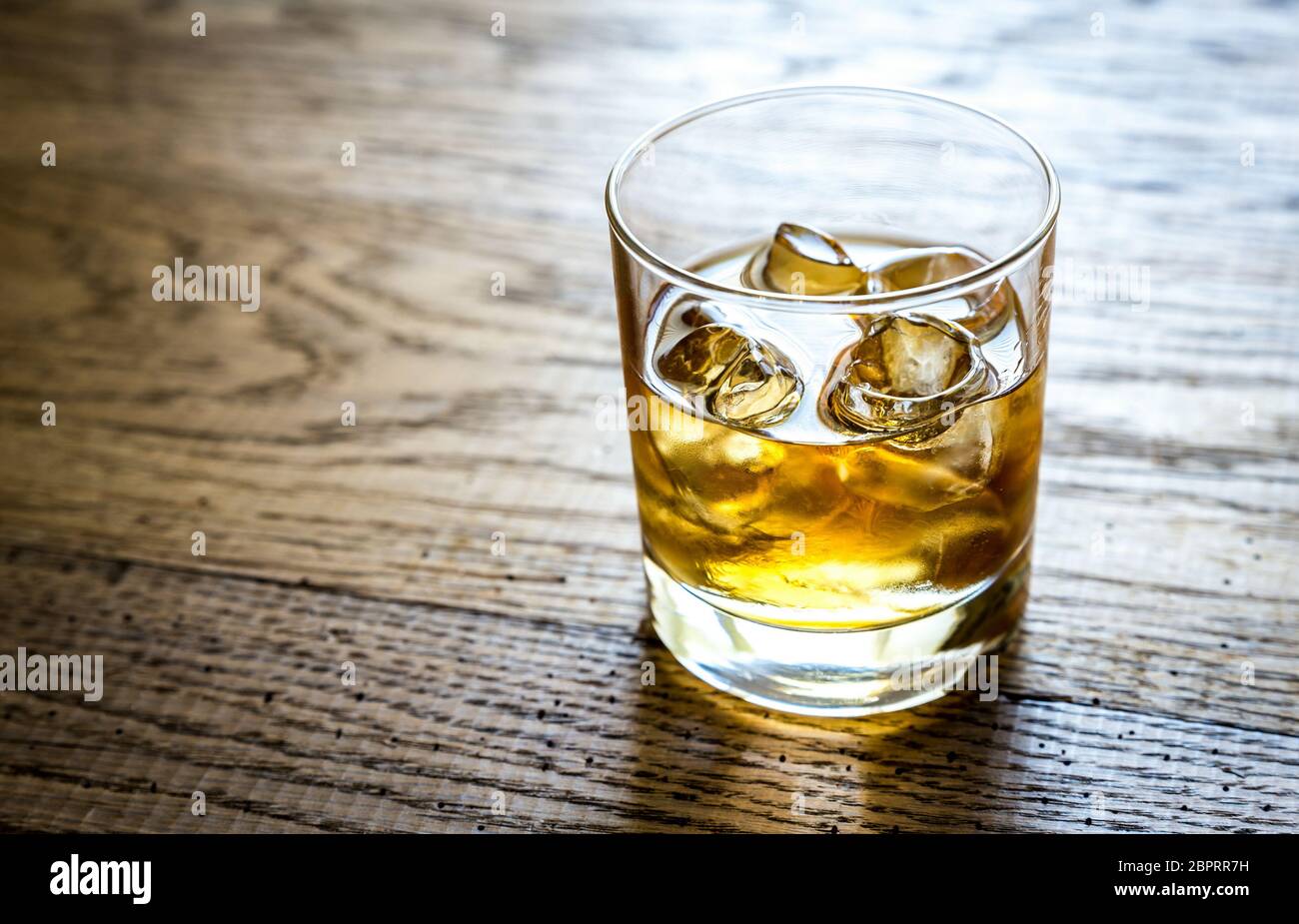 Glass of rum on the wooden background Stock Photo - Alamy