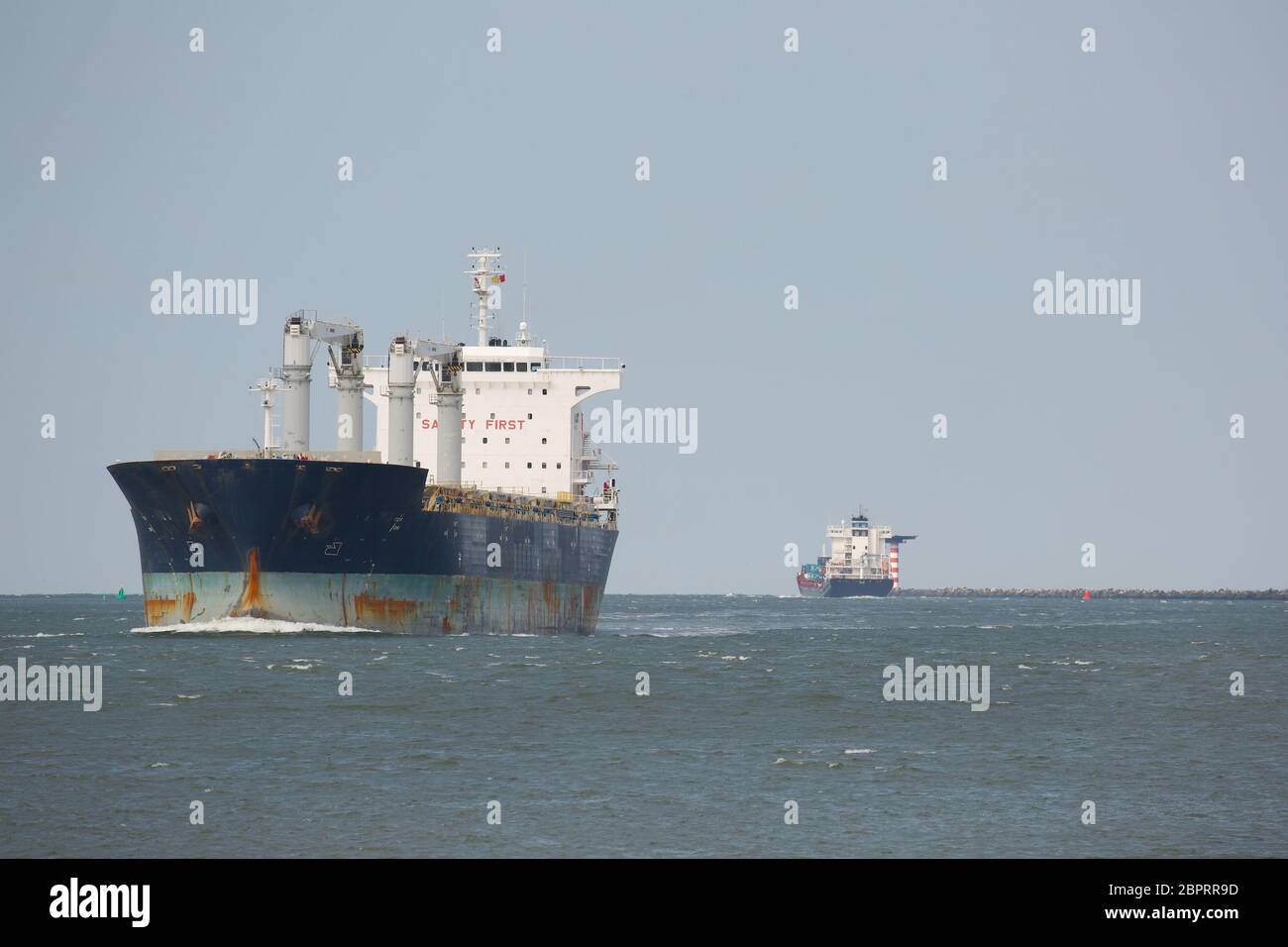 Industrial ship coming in port Stock Photo - Alamy