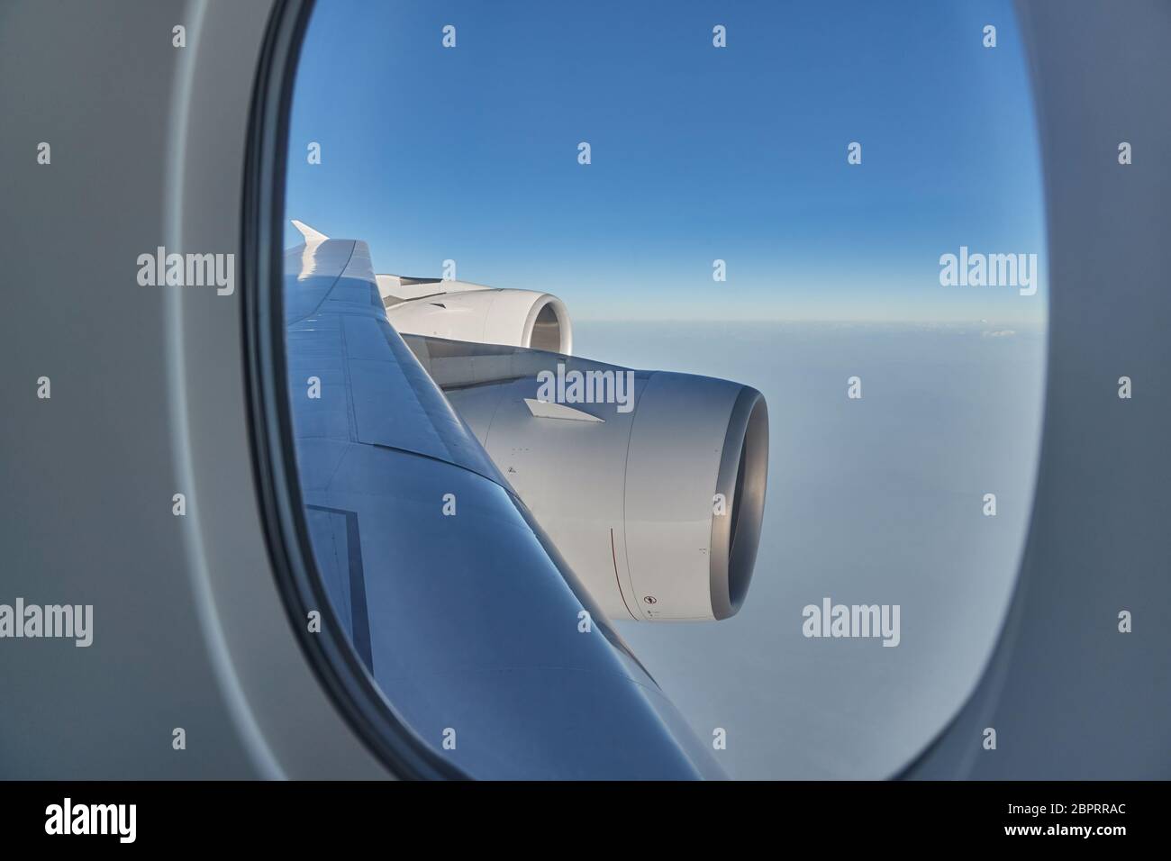 Big jet engines of a four engine wide-body airliner window view during ...