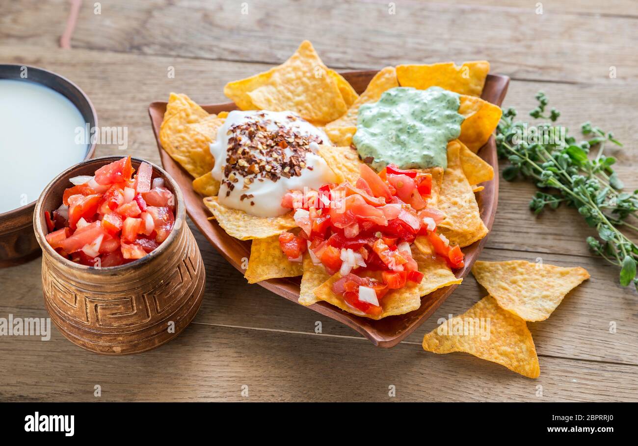 Cheese nachos with different types of sauce Stock Photo - Alamy