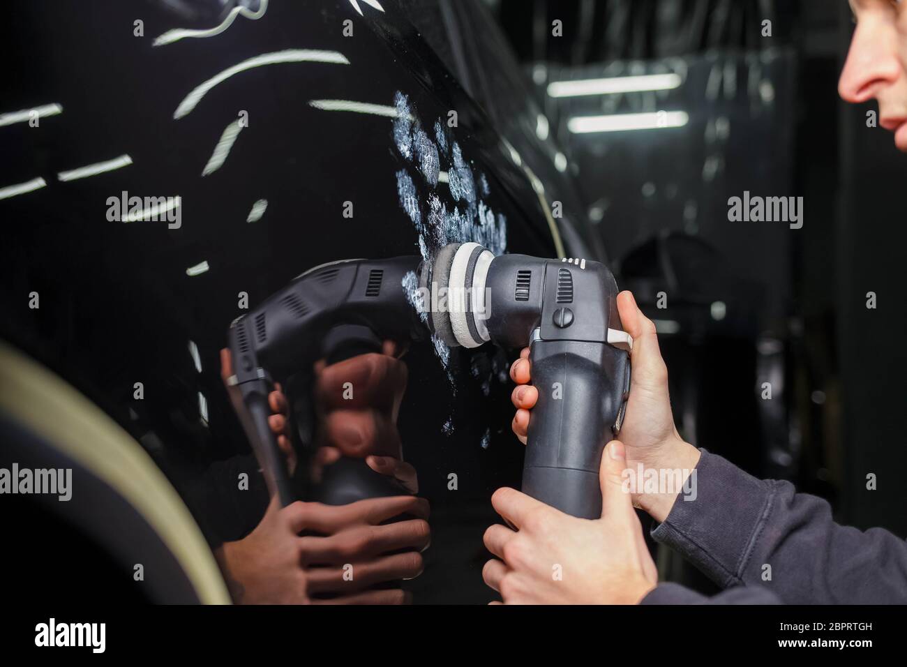 Auto polishing process. Detailing worker polishes car body Stock Photo ...