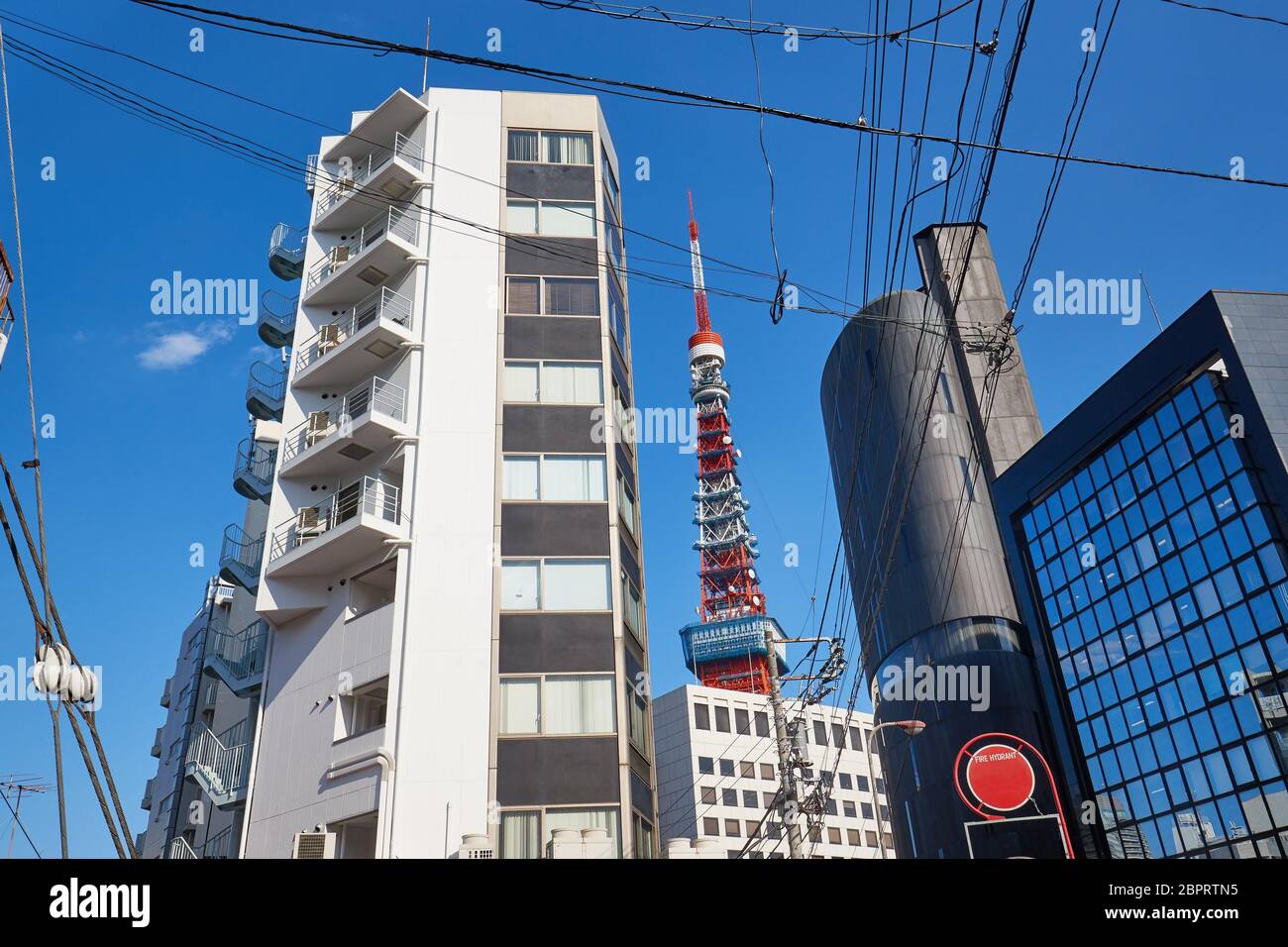 View in the streets of Tokyo with communication tower in the background ...