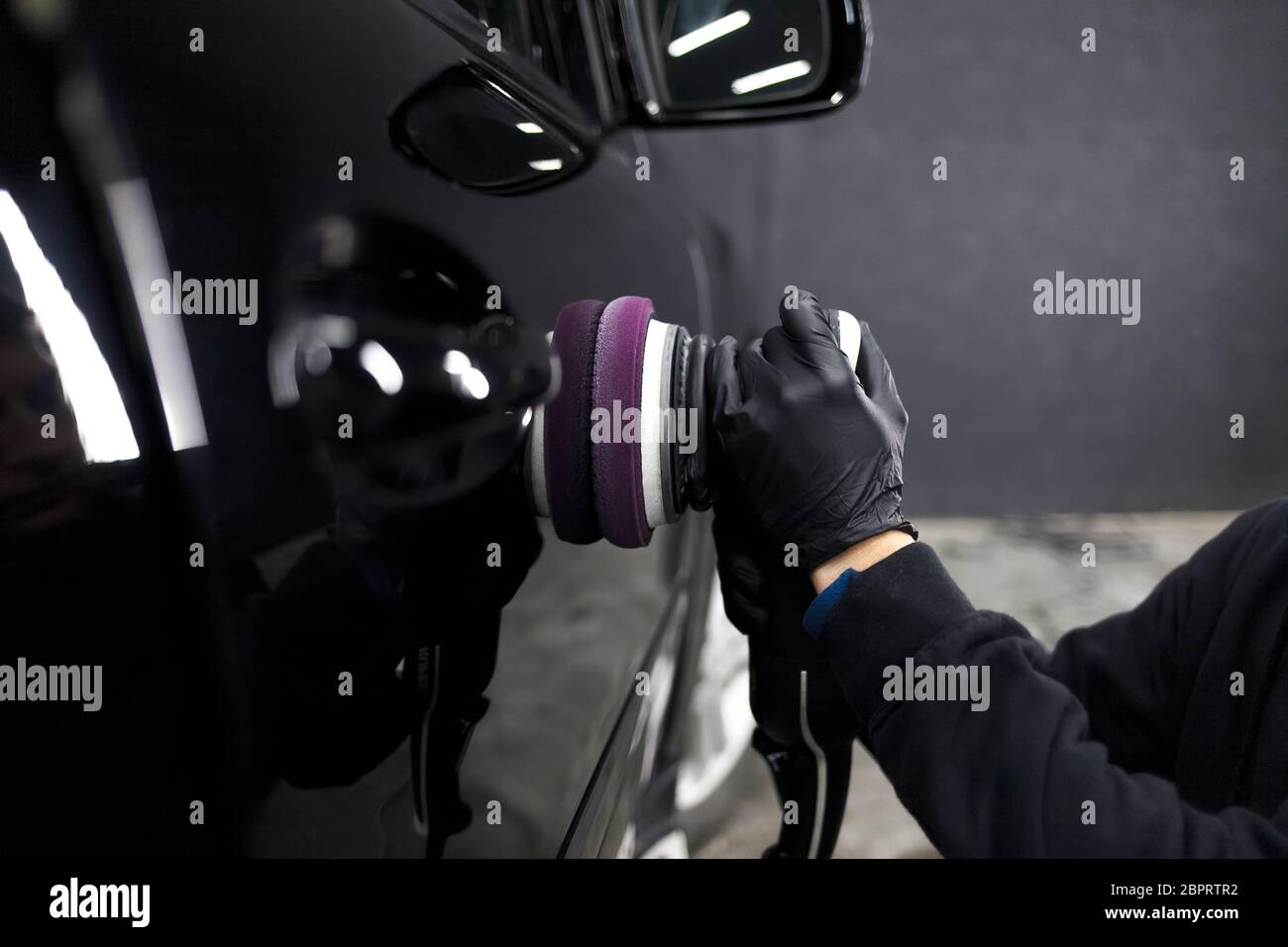 Detailing master polishes the car Stock Photo - Alamy