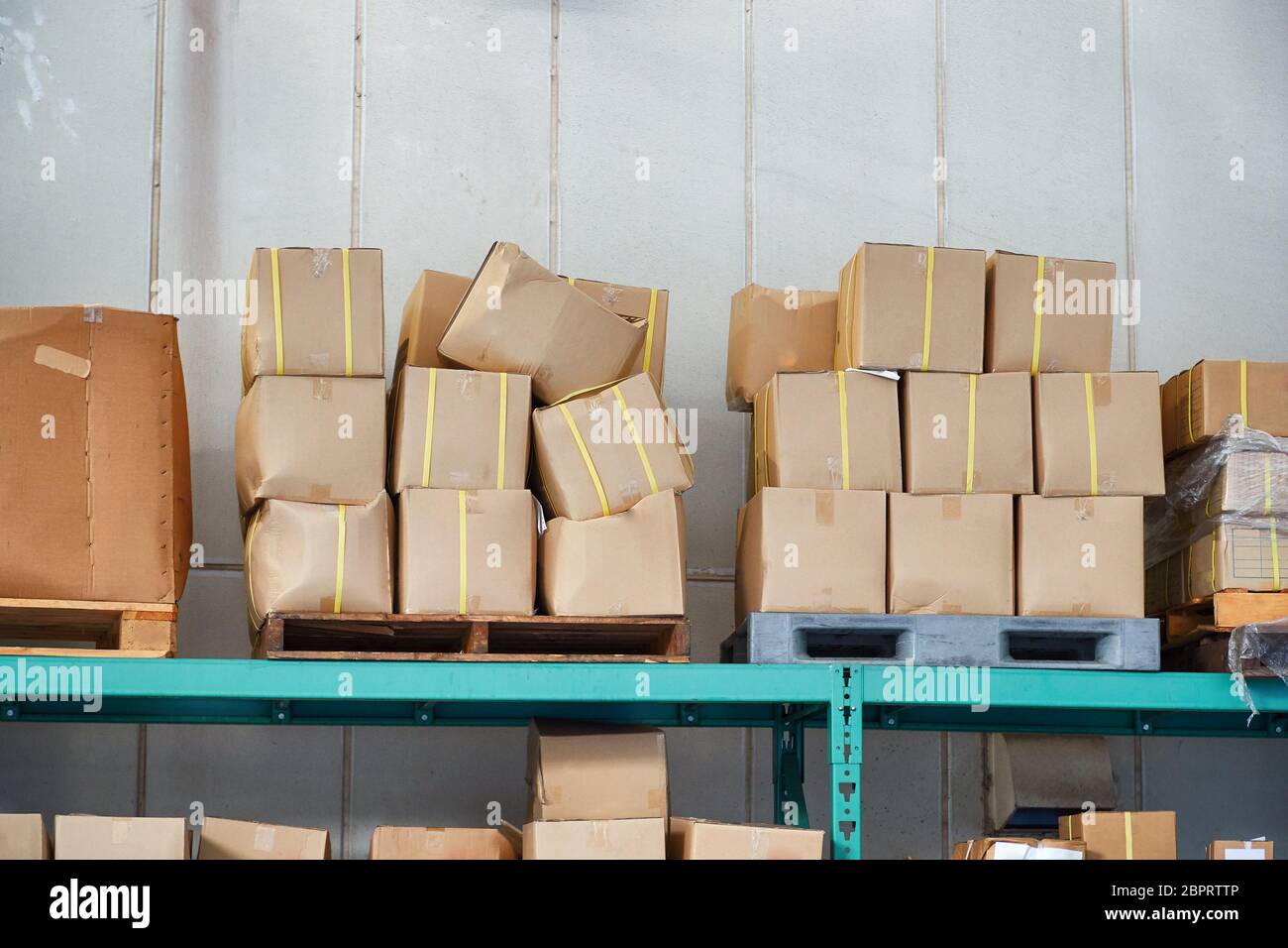 Small warehouse with cardboard boxes Stock Photo - Alamy