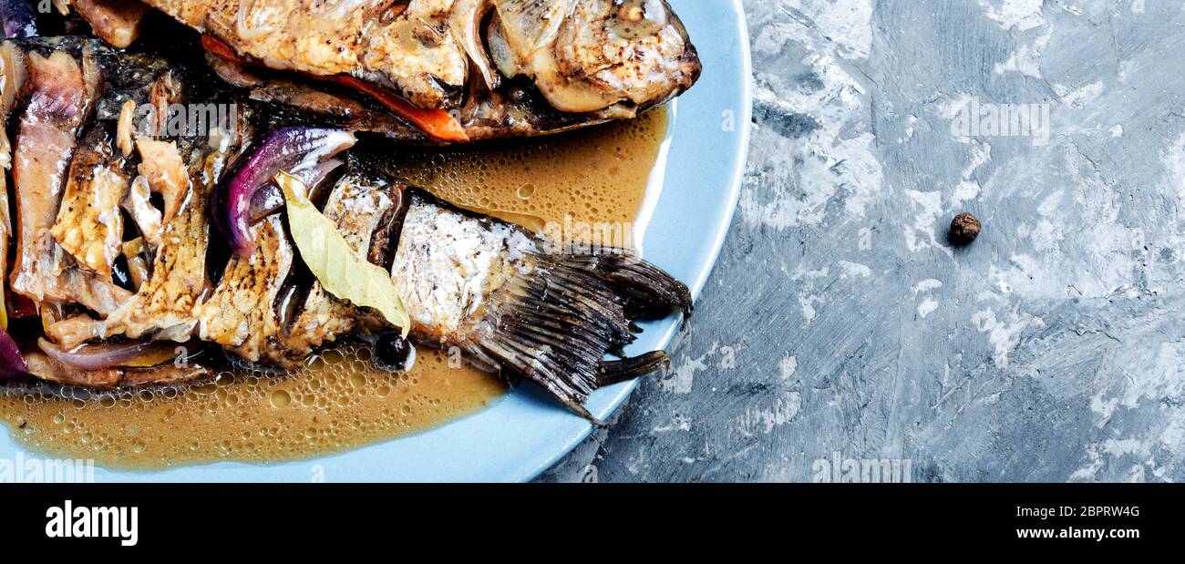 Grilled whole fish with citrus, and vegetable on rustic table Stock ...
