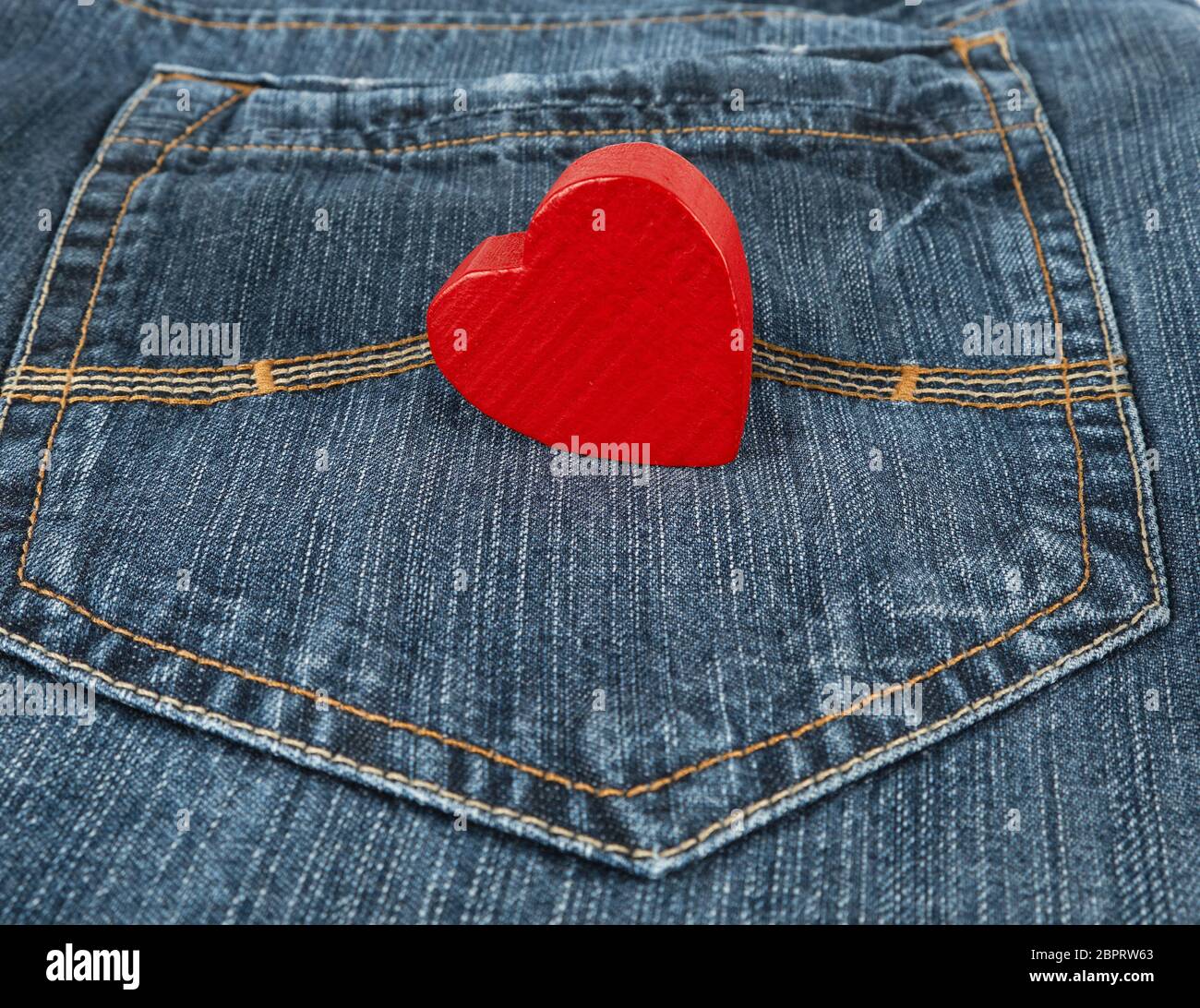 small red heart lies in the back pocket of blue jeans, close up Stock ...