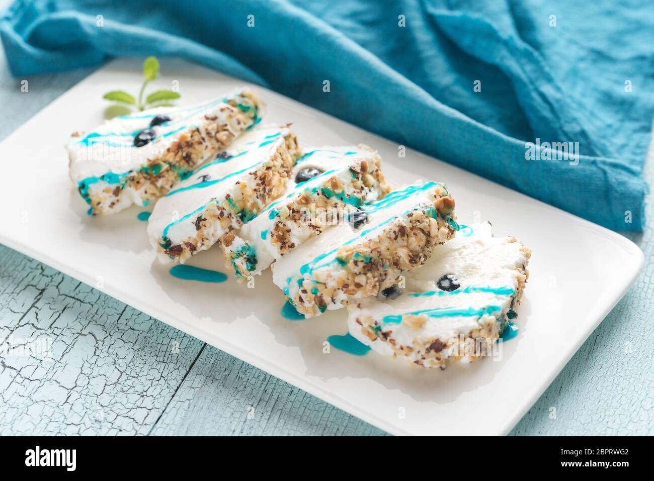 Sliced merengue roll with nuts Stock Photo - Alamy
