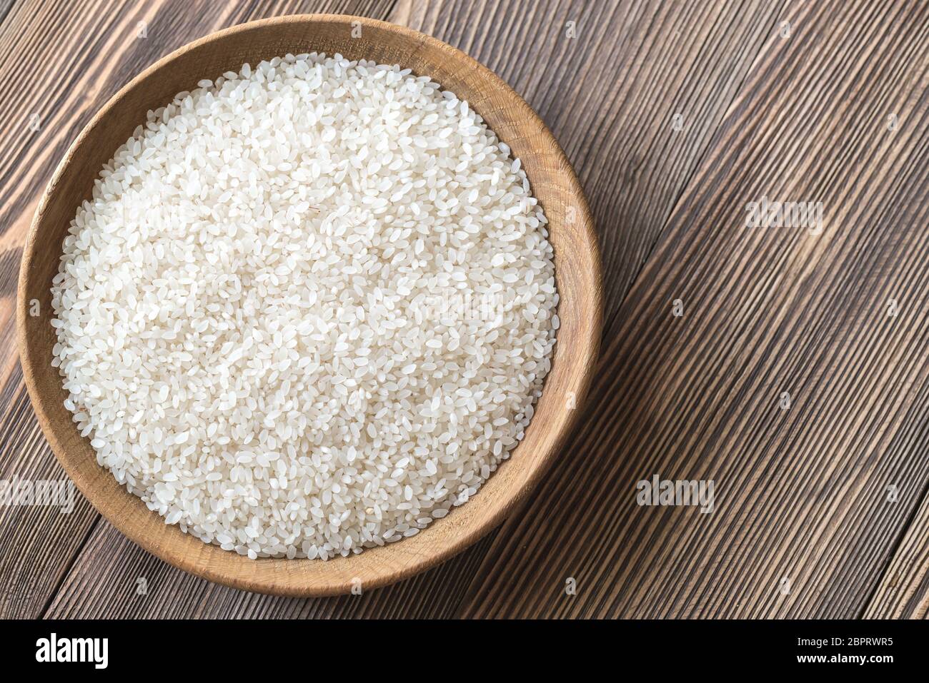Bowl of uncooked camolino rice Stock Photo - Alamy