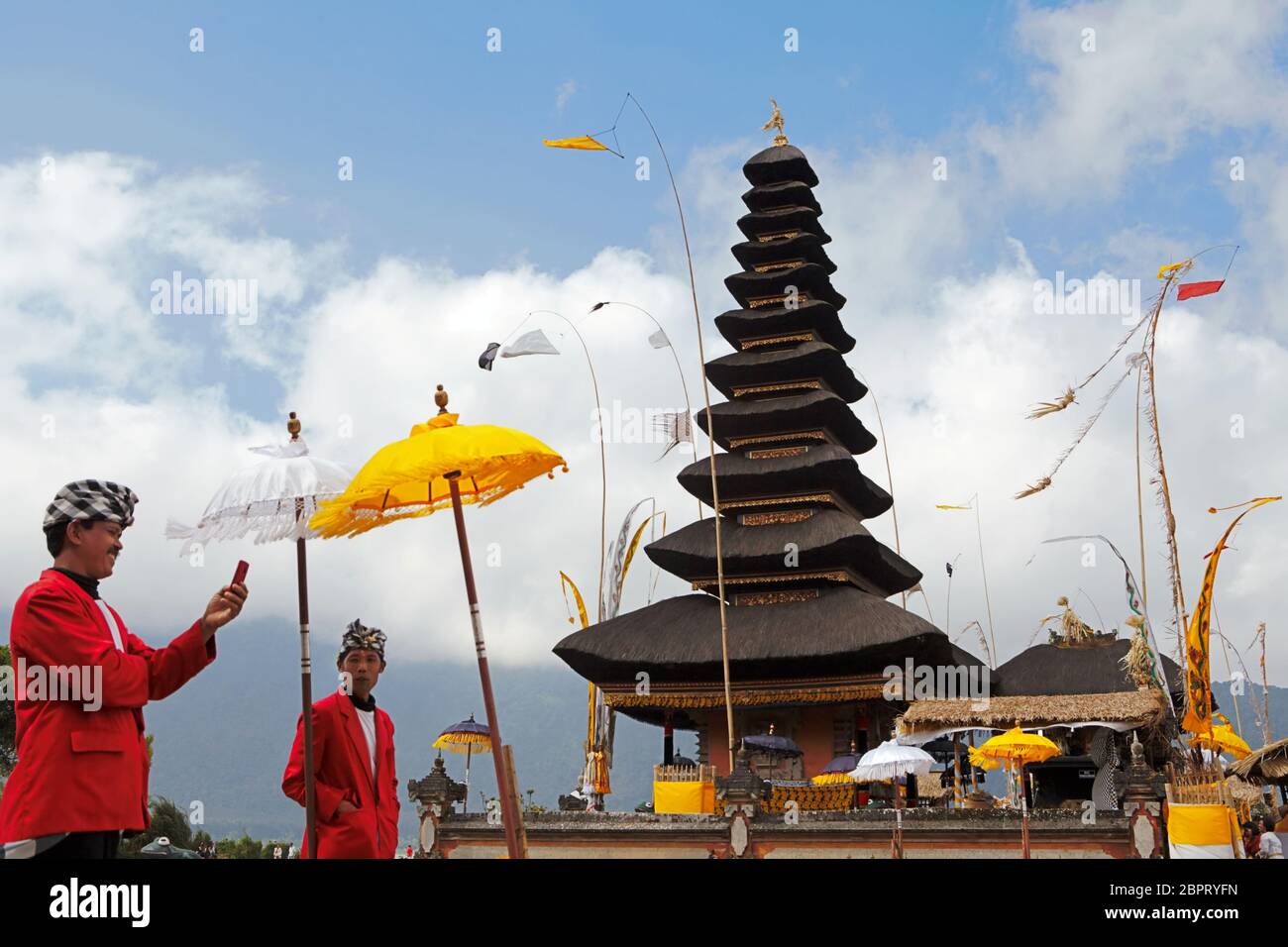 Pecalang (traditional Balinese policemen) taking a break for mobile ...