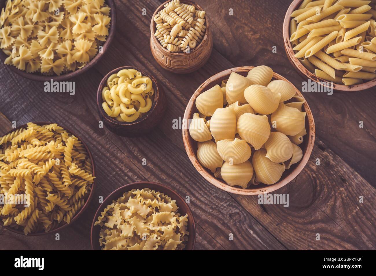 Various types of pasta on the white background Stock Photo - Alamy