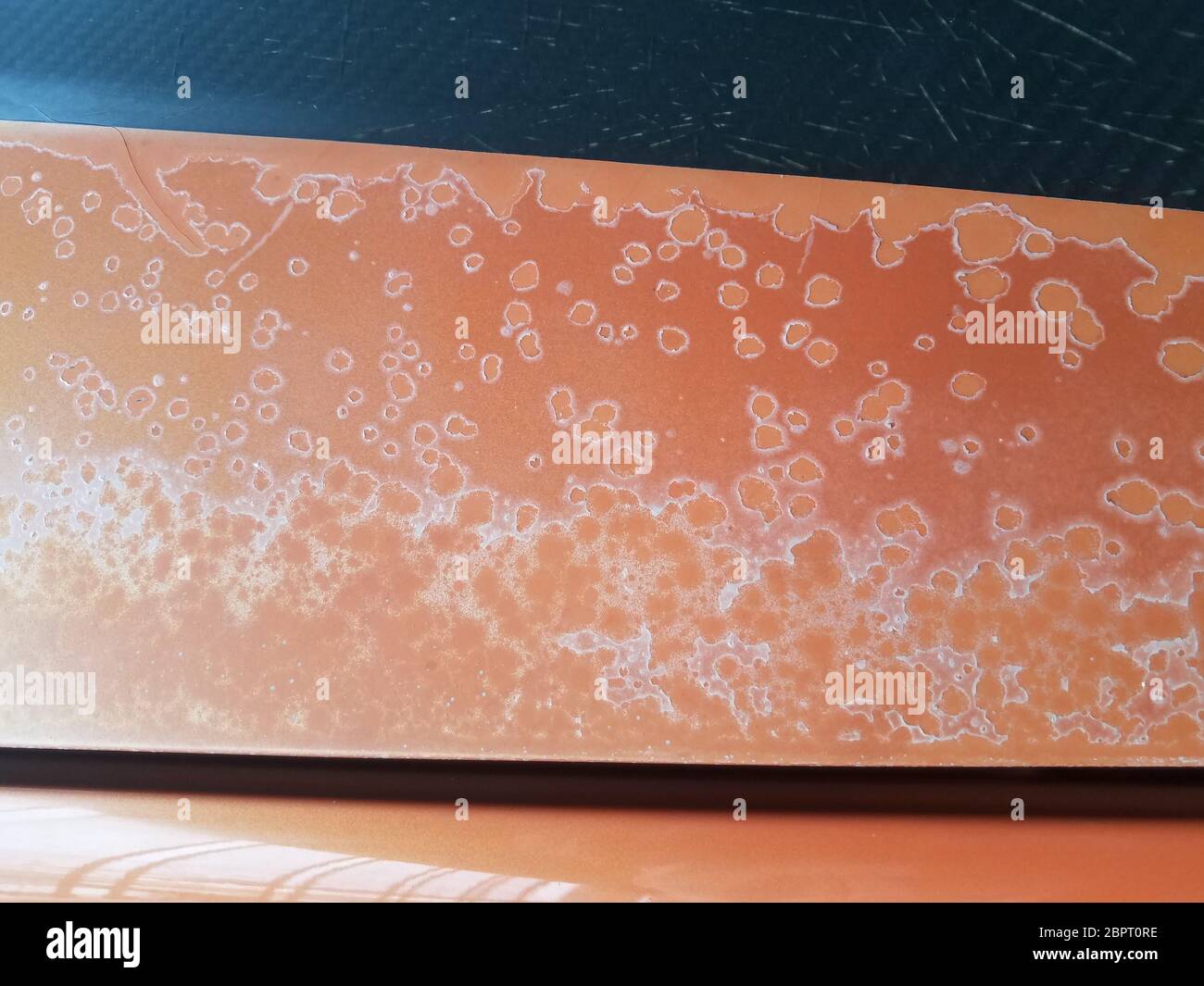 corrosion or damage on weathered orange car or automobile Stock Photo ...