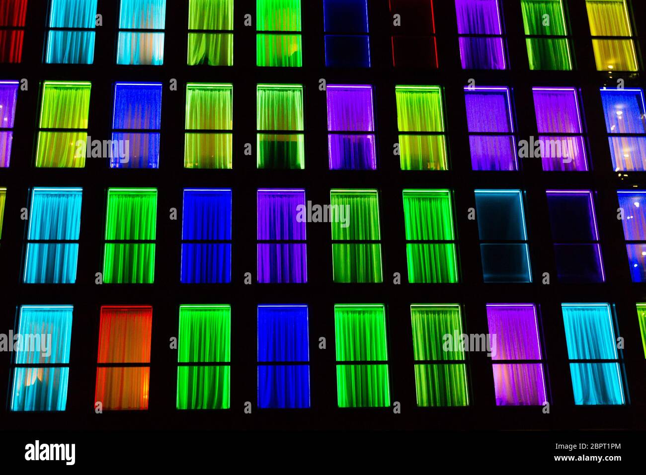 Colored windows texture. Windows illuminated by neon lights background ...