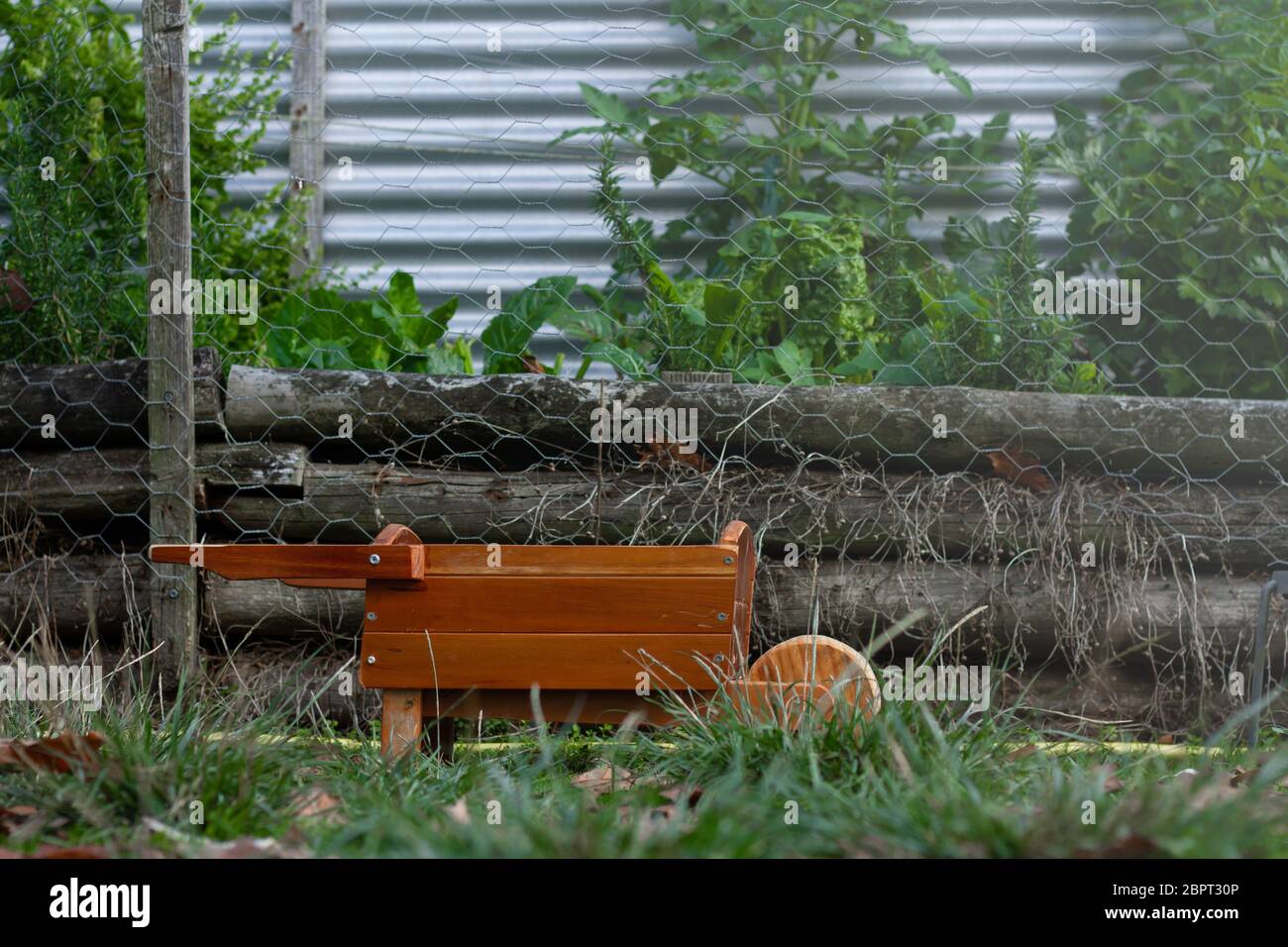 A small wooden wheelbarrow Stock Photo - Alamy