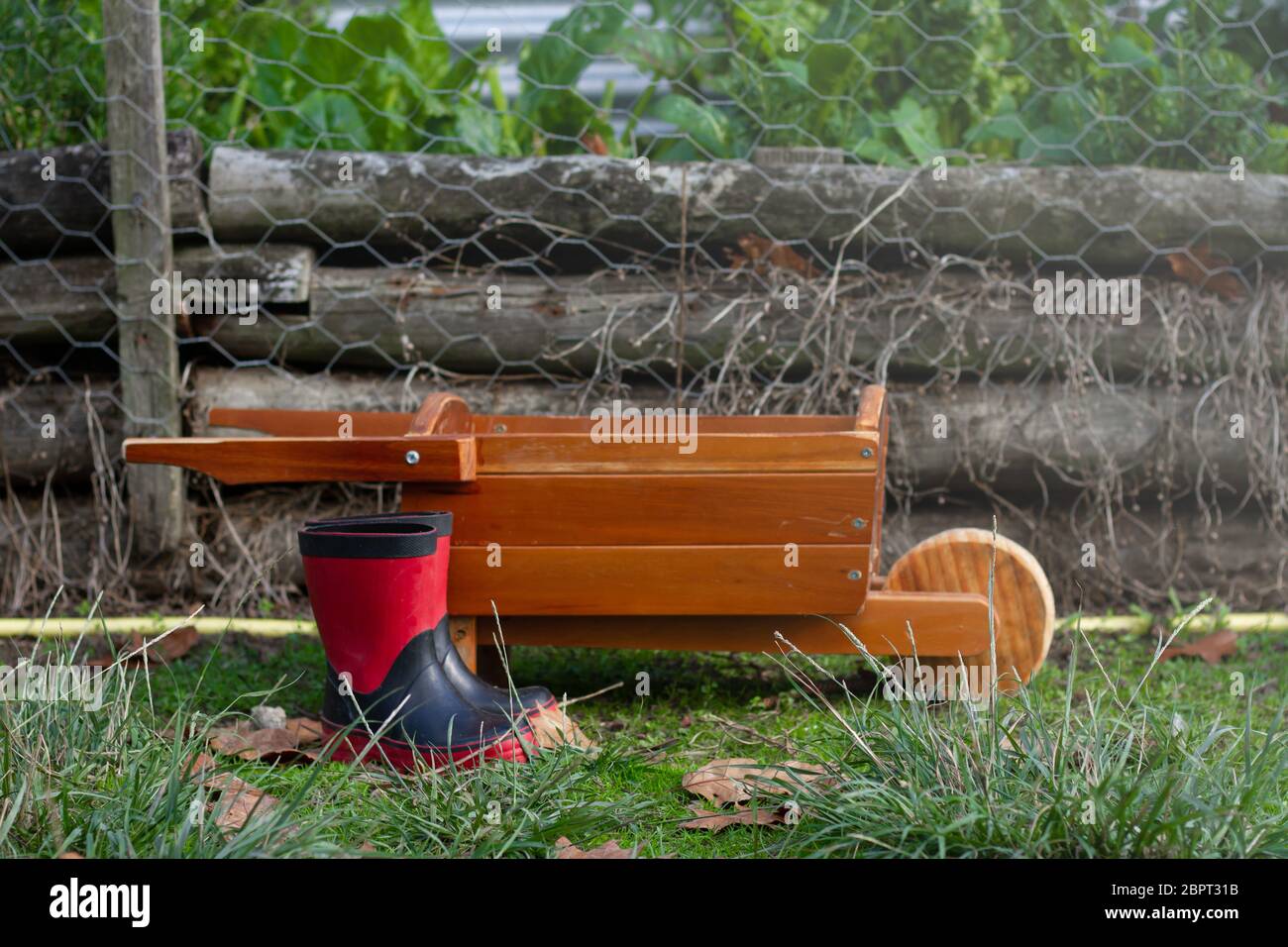 A small wooden wheelbarrow Stock Photo - Alamy