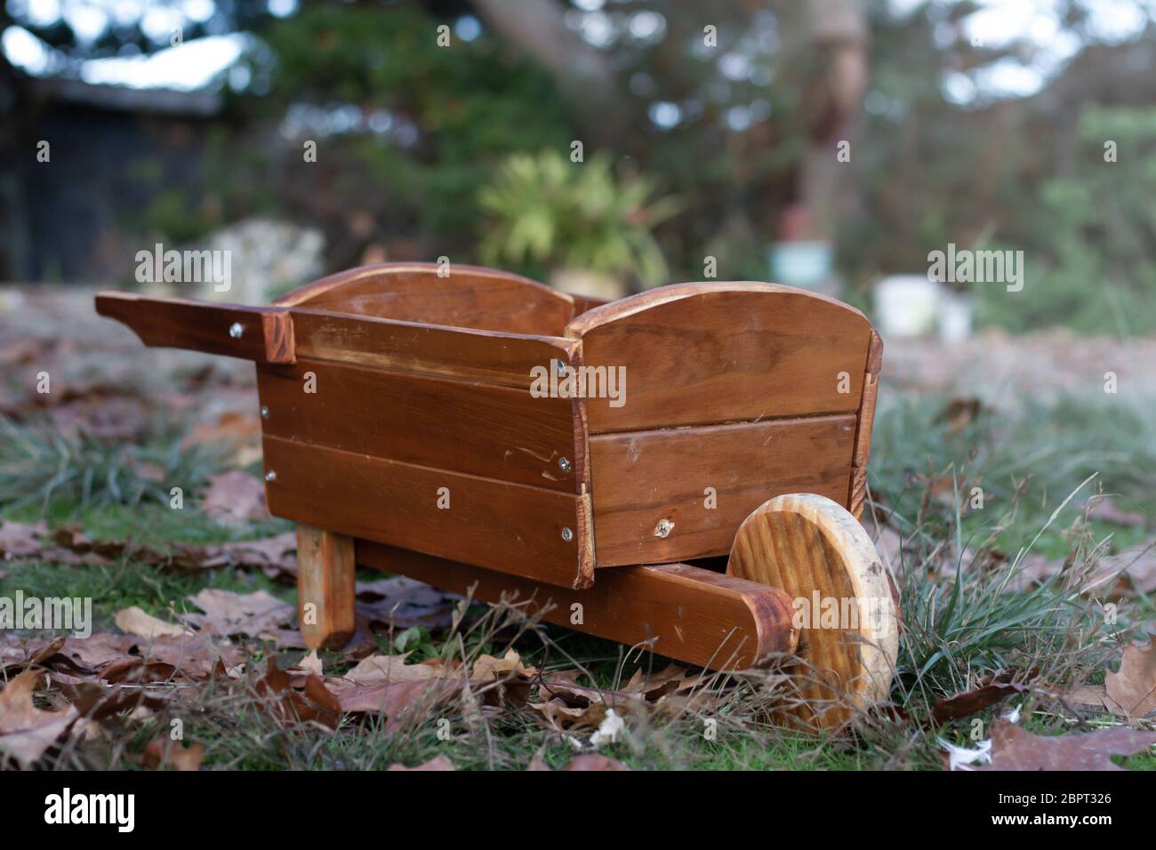 A small wooden wheelbarrow Stock Photo - Alamy